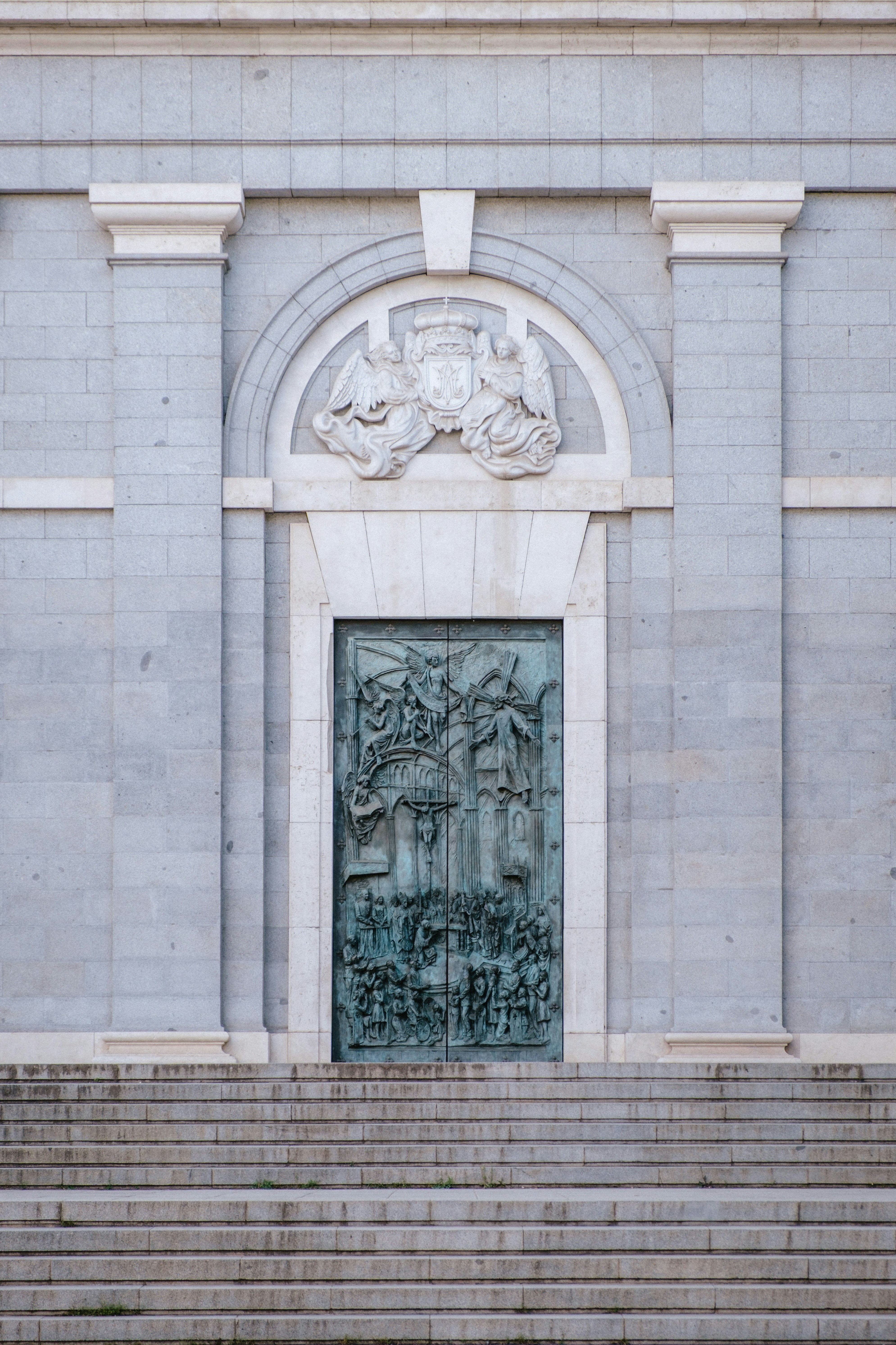 Grand bronze door with detailed reliefs, madrid