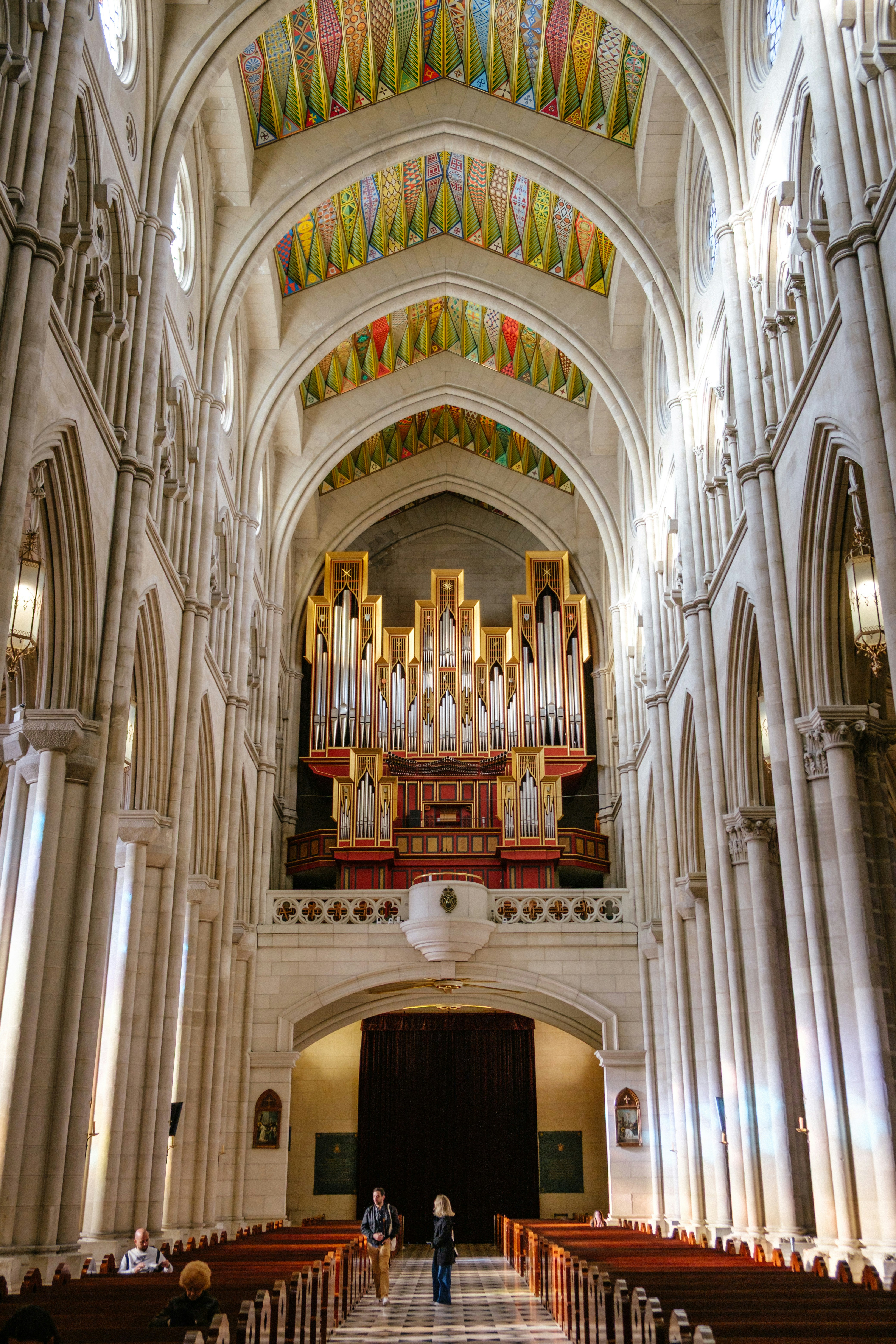 Echoes of Stone and Pipework: Cathedral Nave Beneath Golden Organ