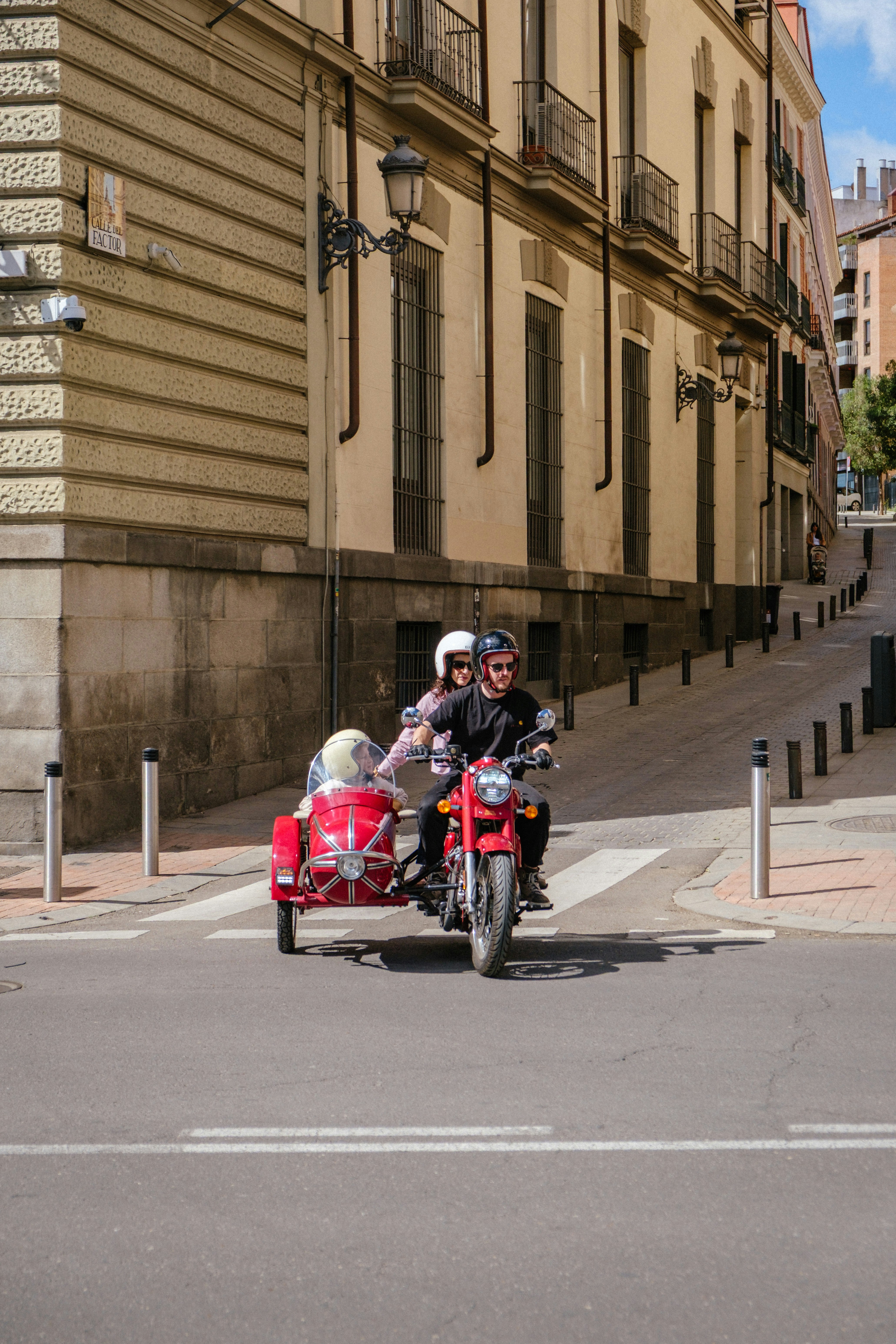 Streetside Ride: Vintage Red and Chrome on a Corner of Madrid