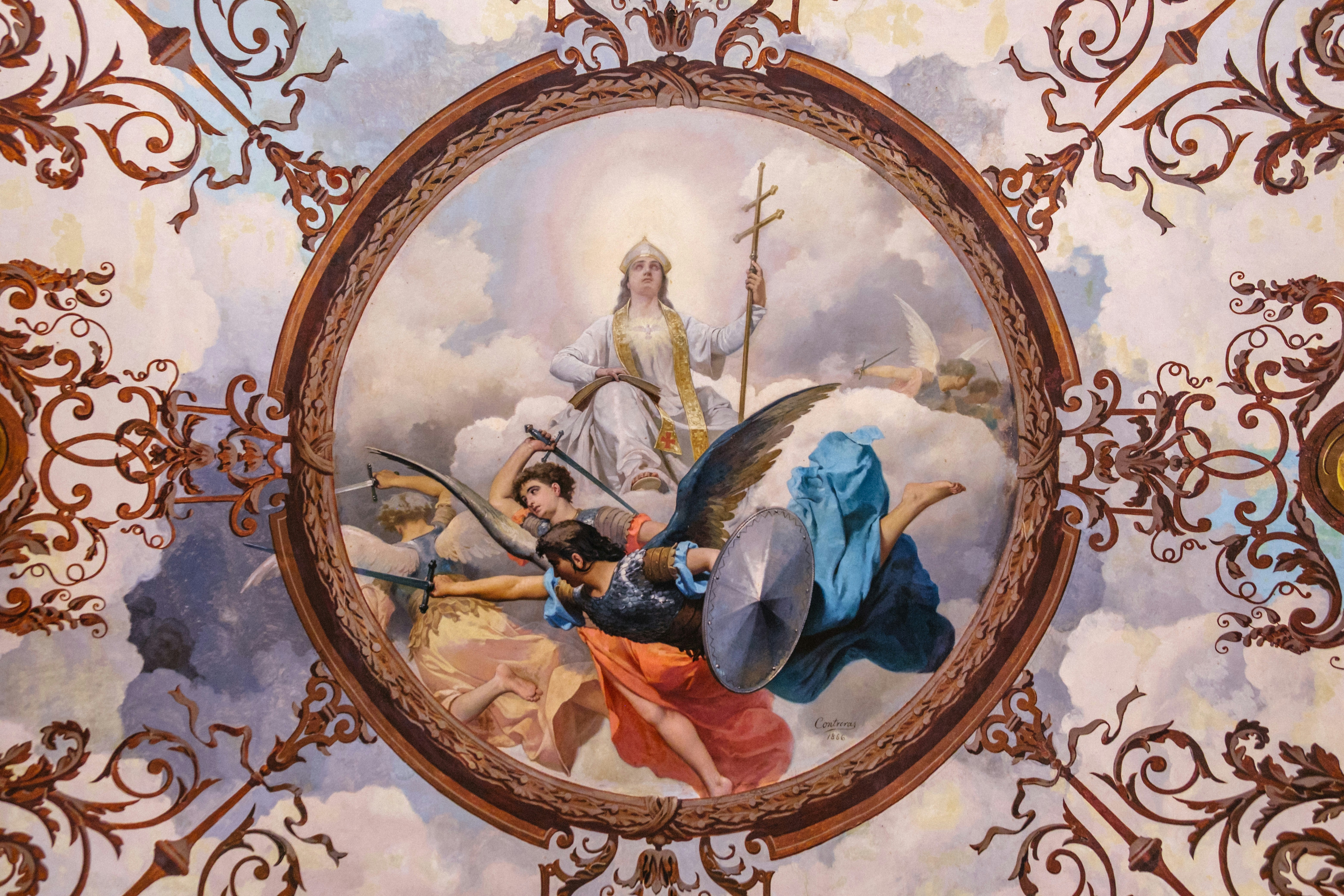 Circular Angelic Tableau: A Skyward Frieze Framed by Ornate Ironwork