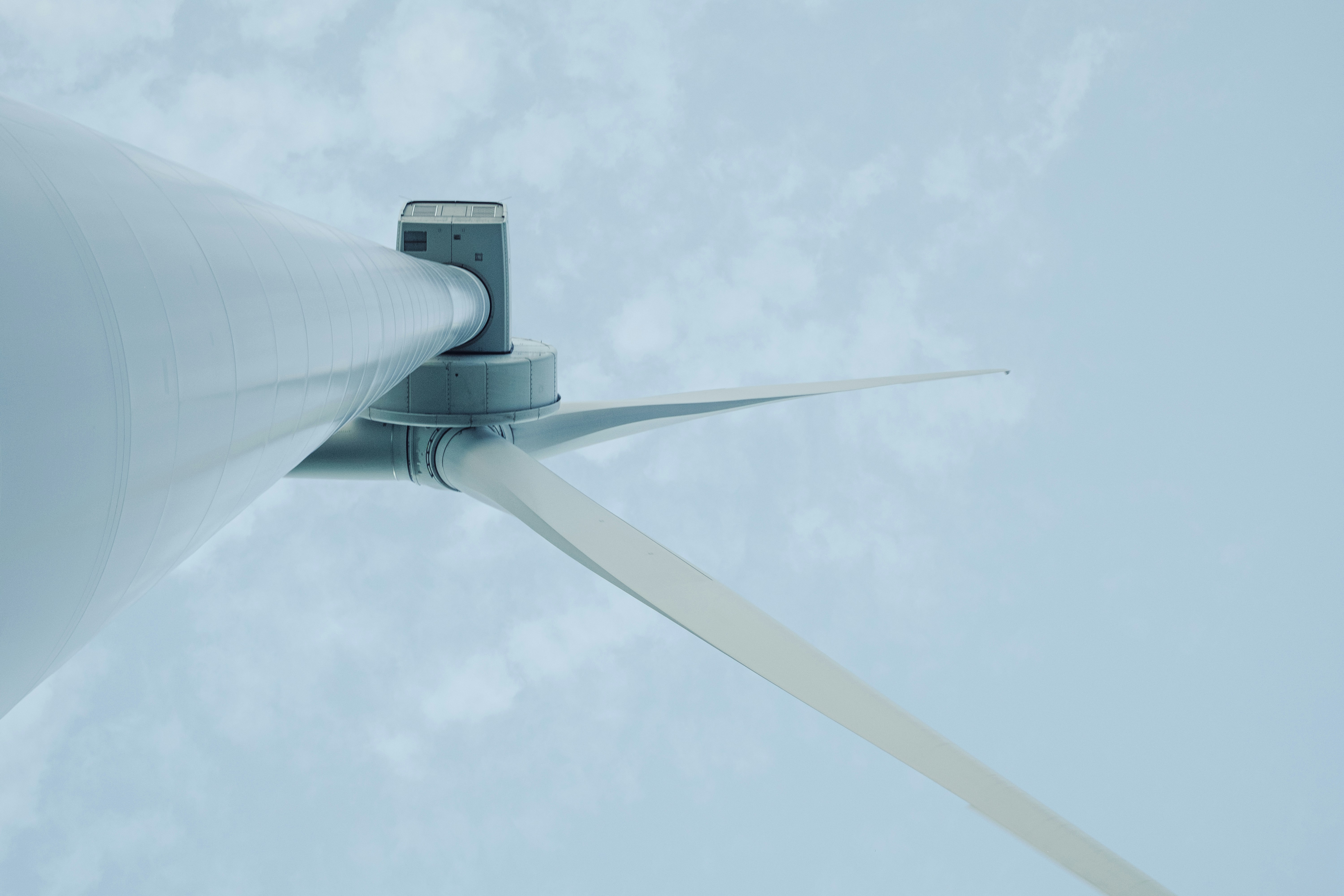 Upward Gaze: A Wind Turbine Reaching into a Pale Sky
