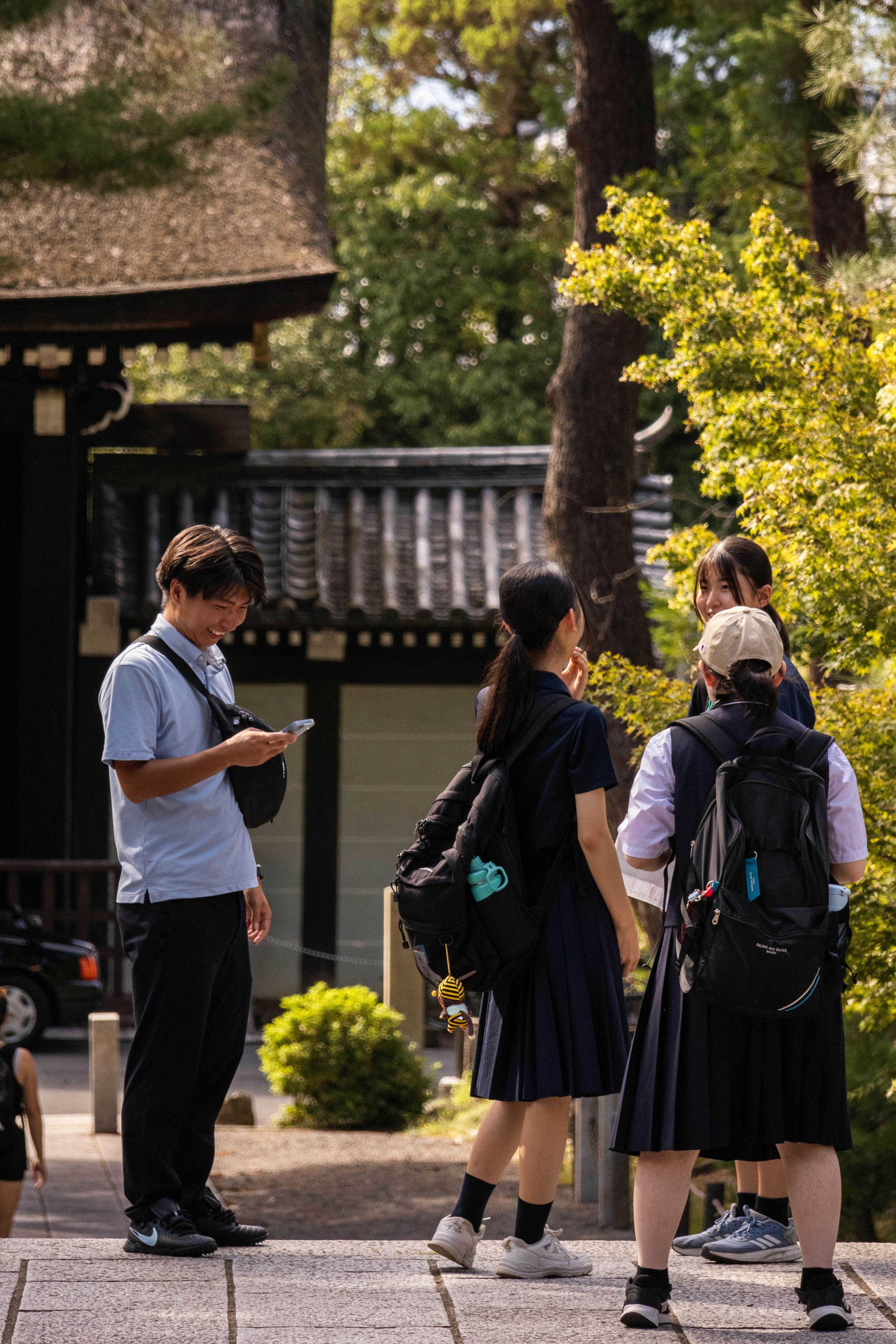 Group of Students at a Temple Courtyard, Lights and Shadows Framing their Conversation
