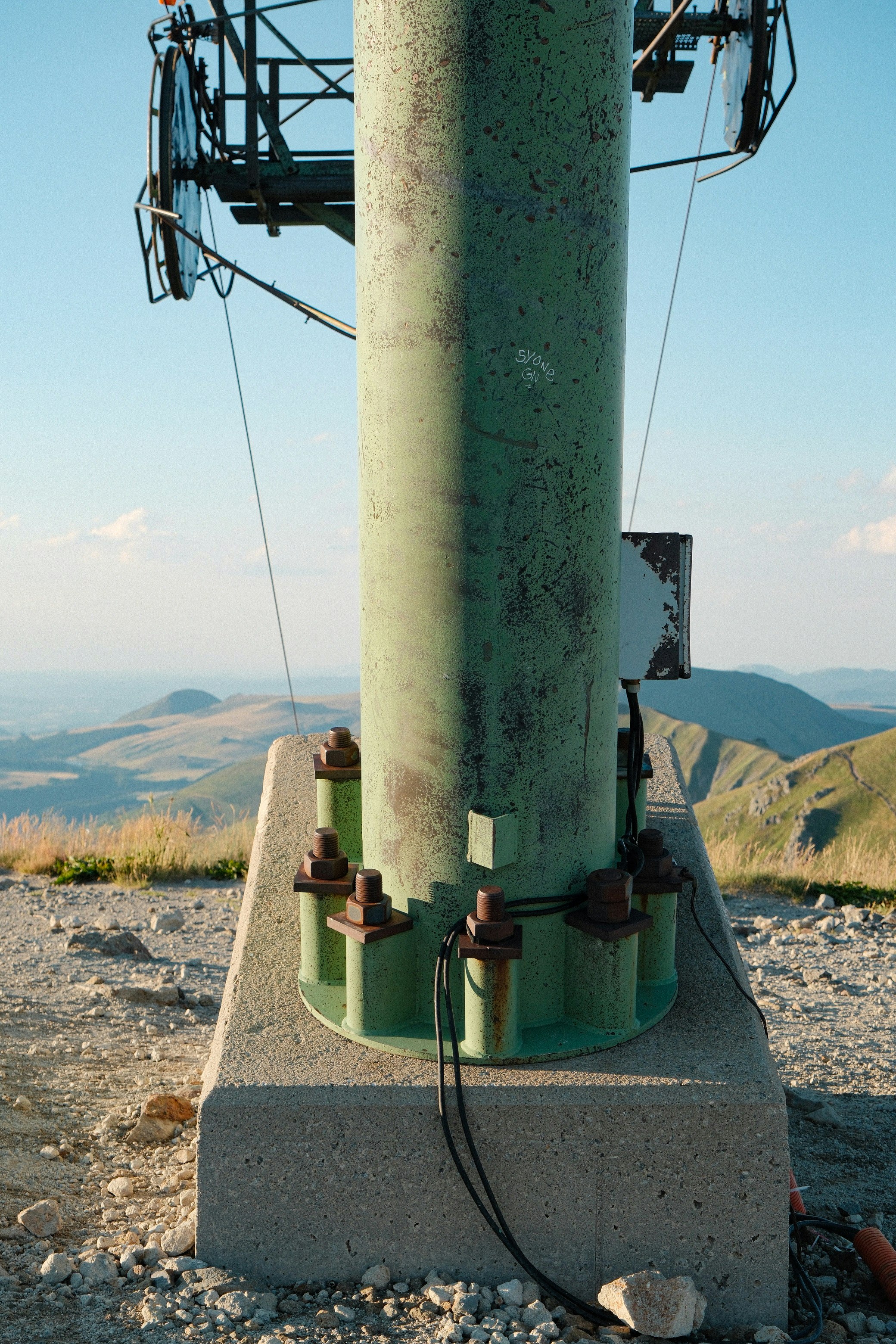 Ridge-top Cable Mast: Rust, Concrete, and Horizon