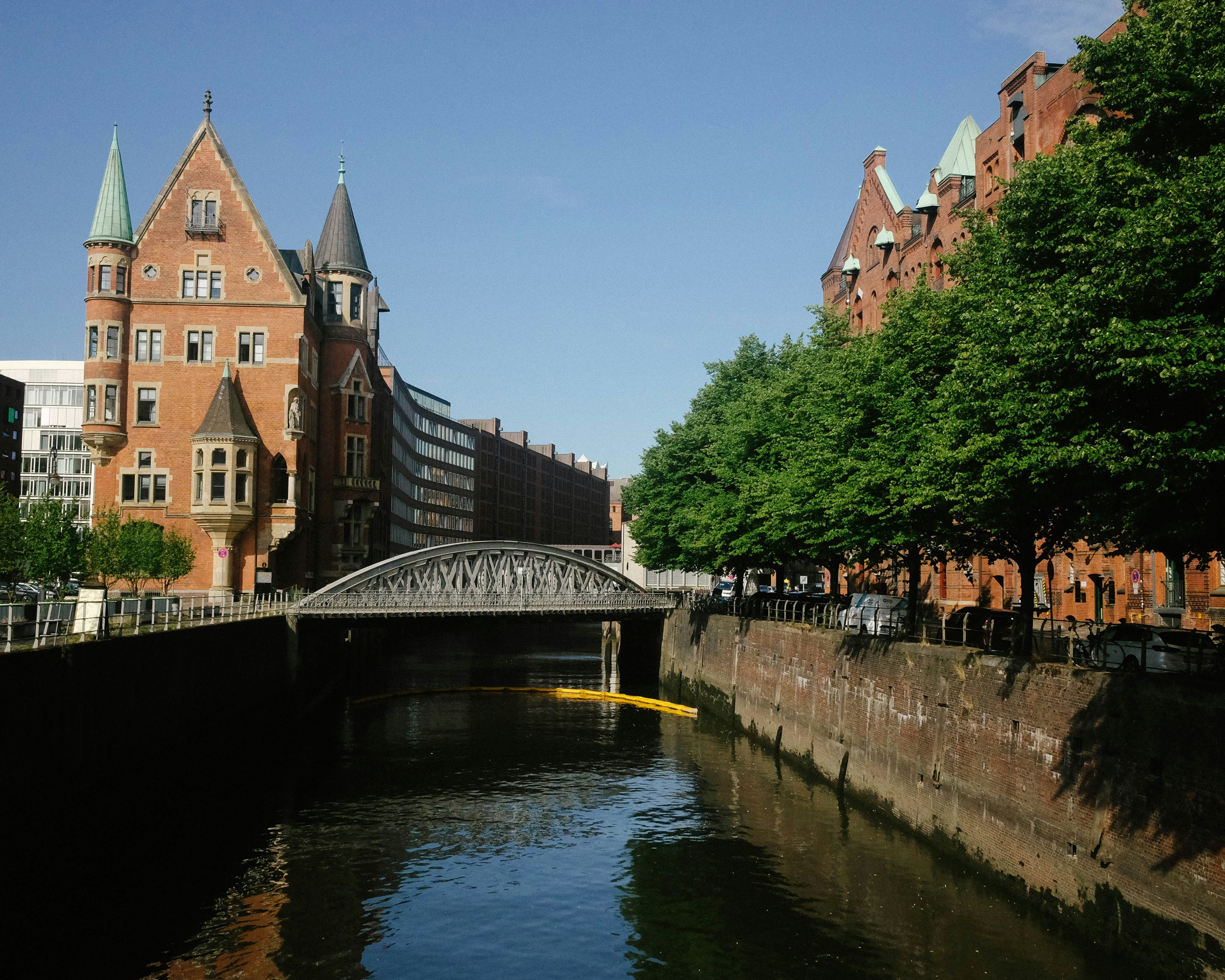 Harbor of Brick and Cedar: A City Canal Amid Historic Towers