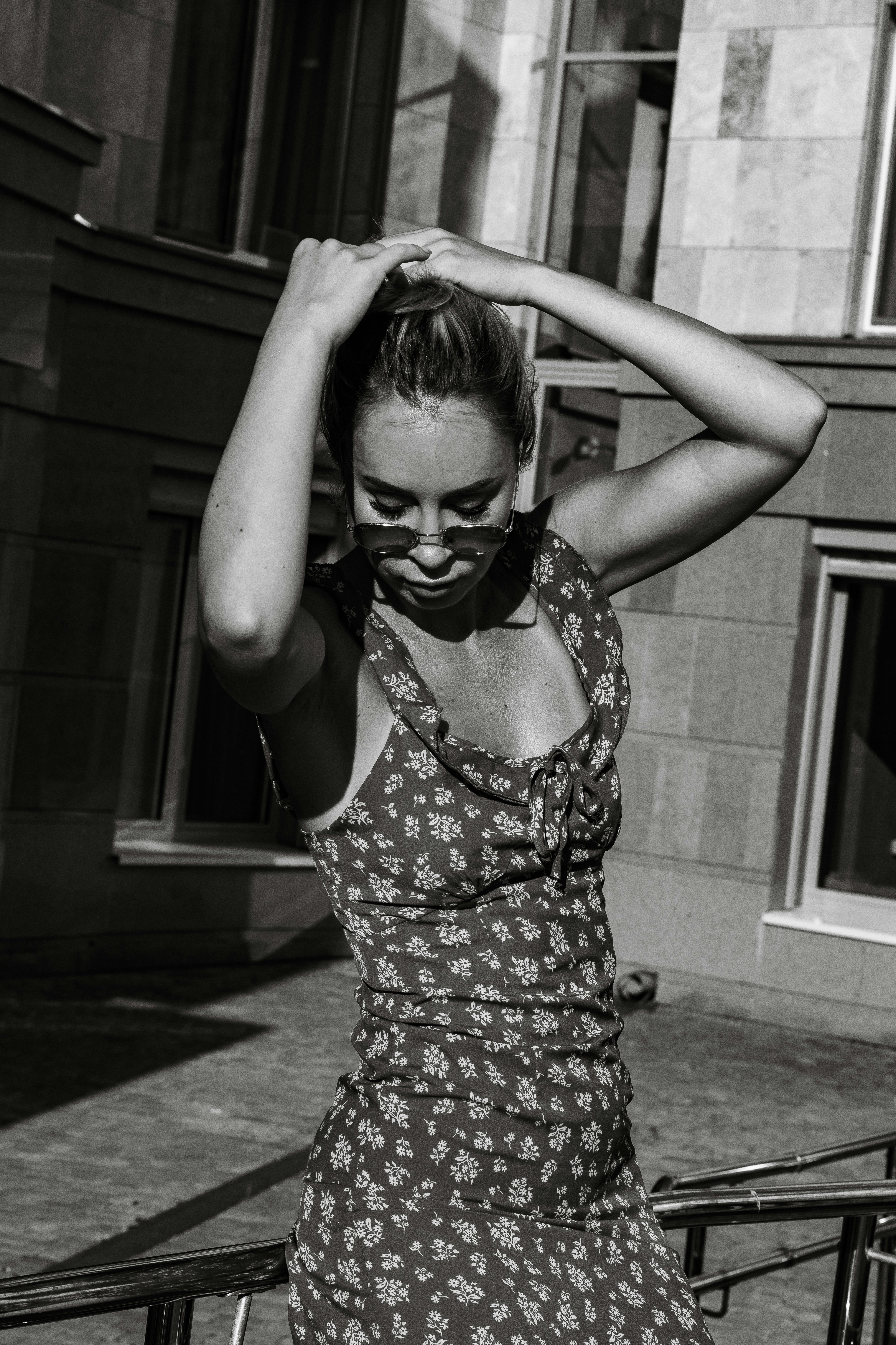 Shadowed Elegance: A Sunlit Pose in Floral Quiet