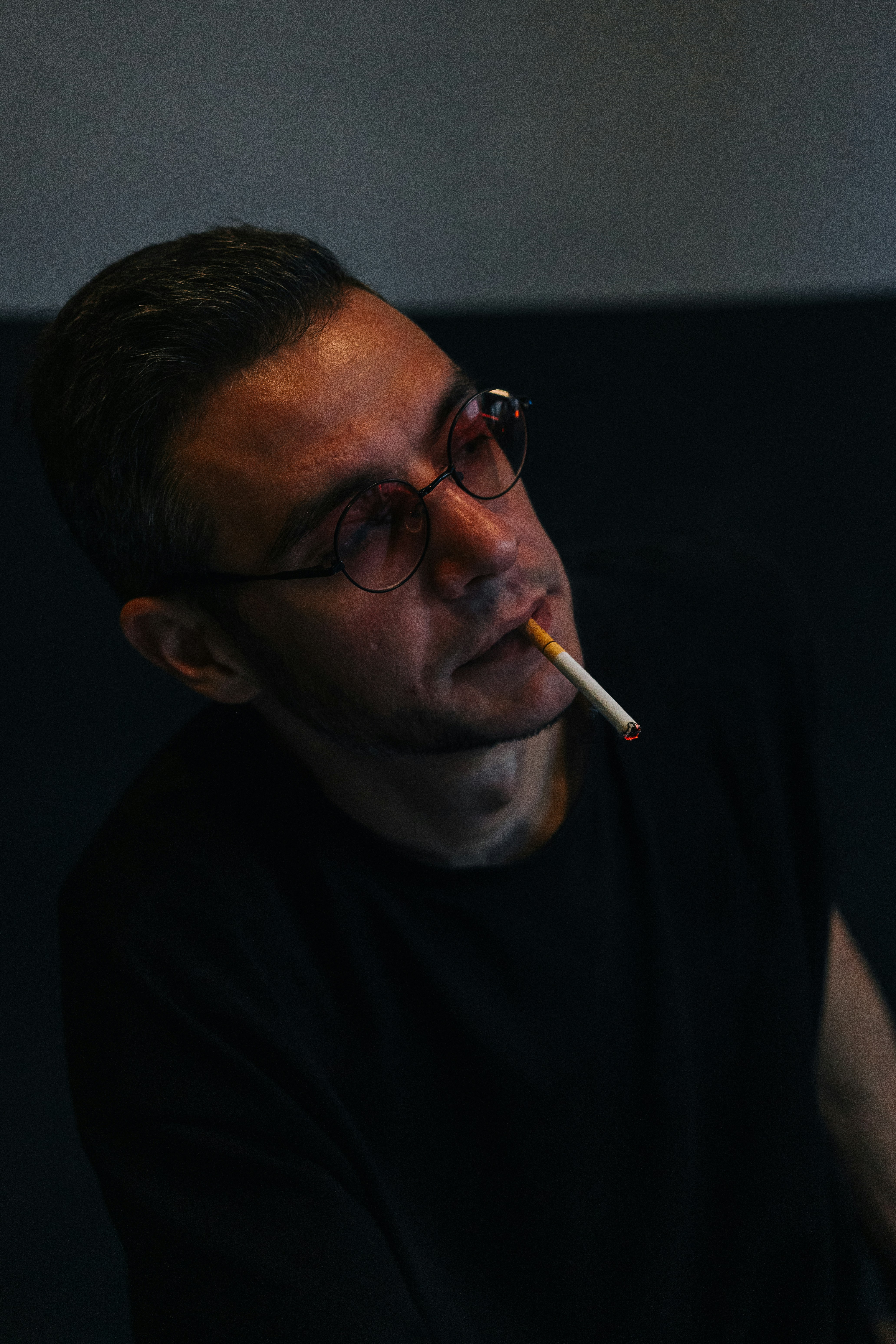 Smoke and Silence: A Focused Portrait in Dim Studio Light