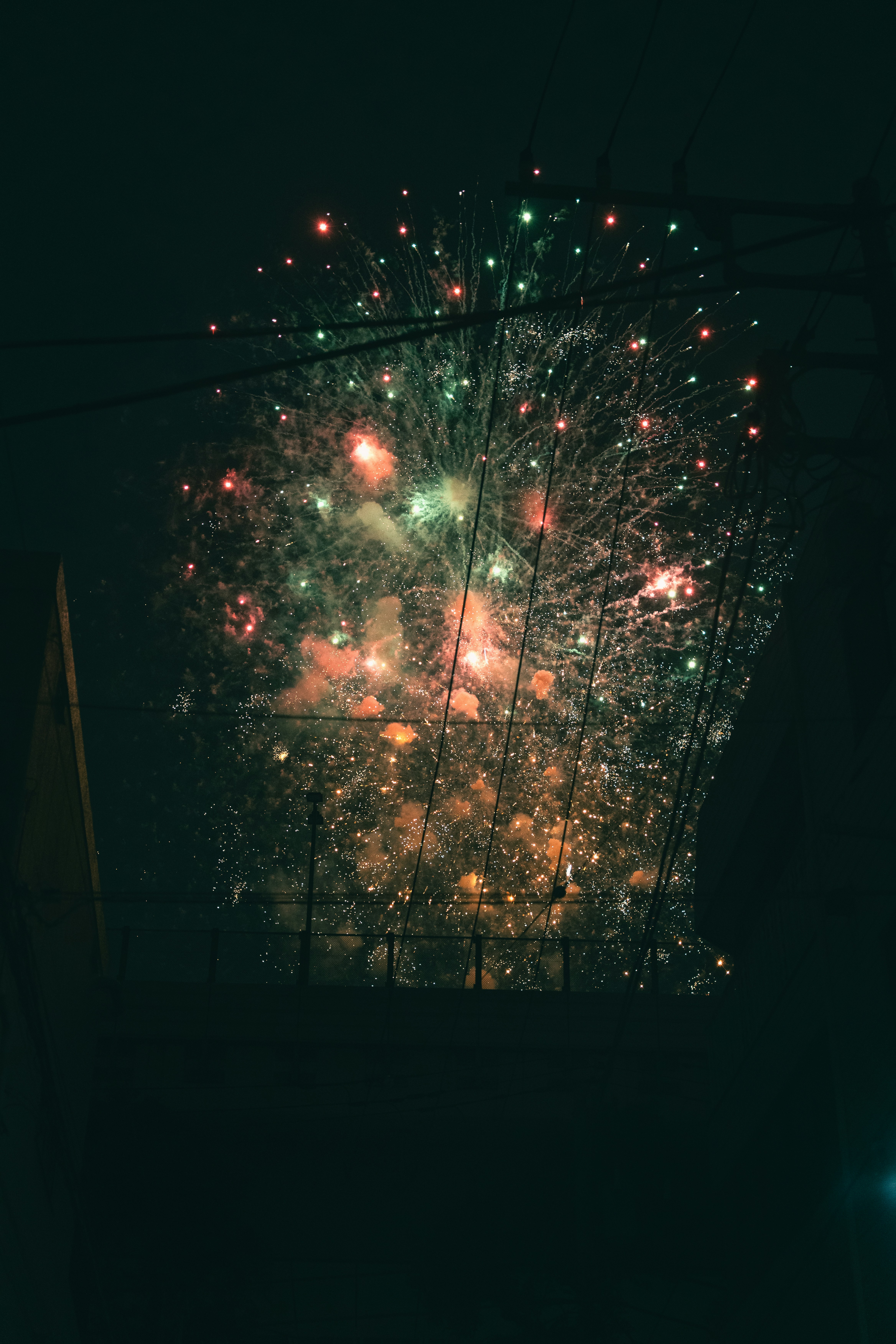 Midnight Skybursts: Fireworks Through Steel and Shadow