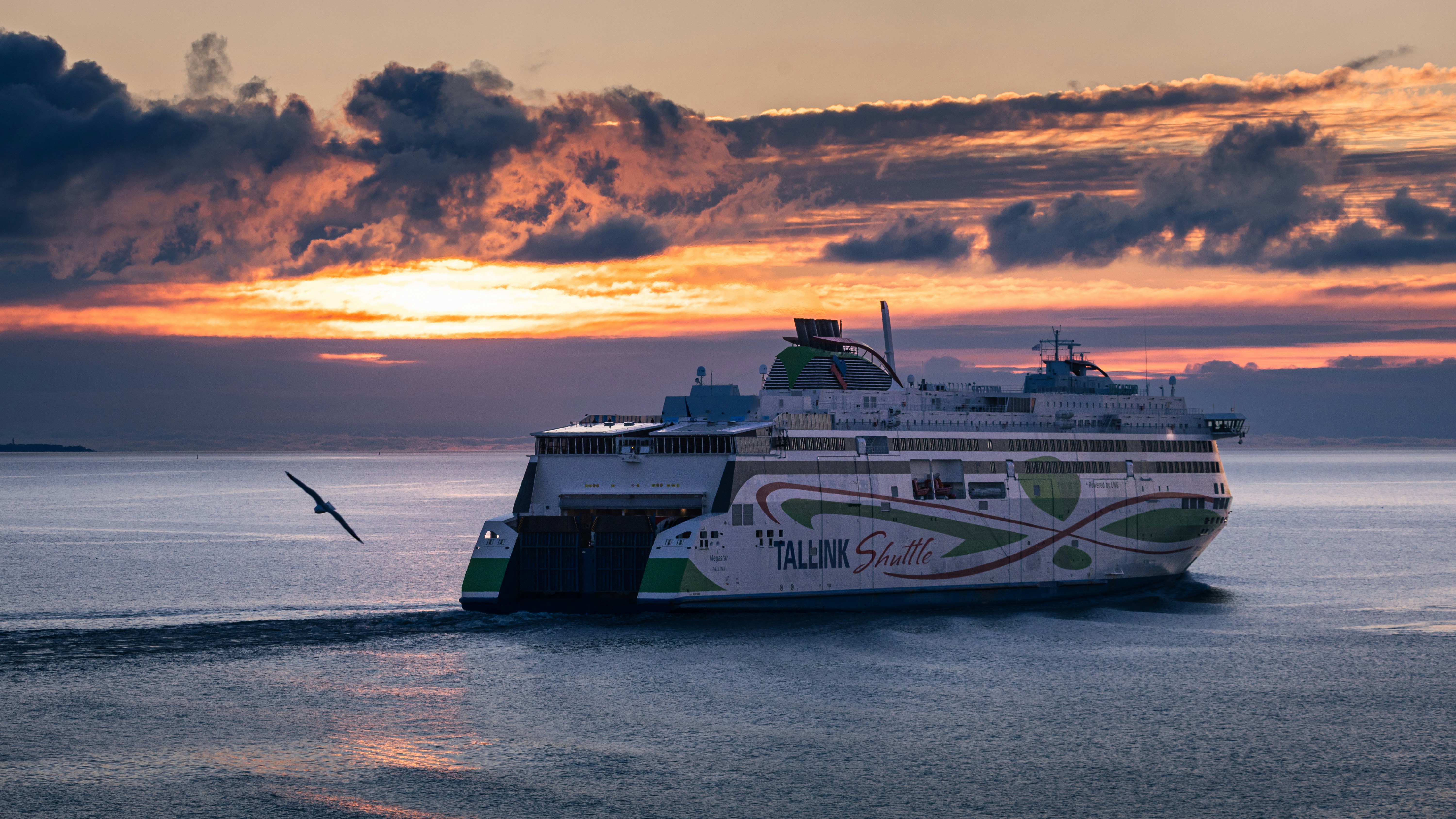 Sunset Crossing: Green-Trim Ferry Gliding Past a Quiet Horizon