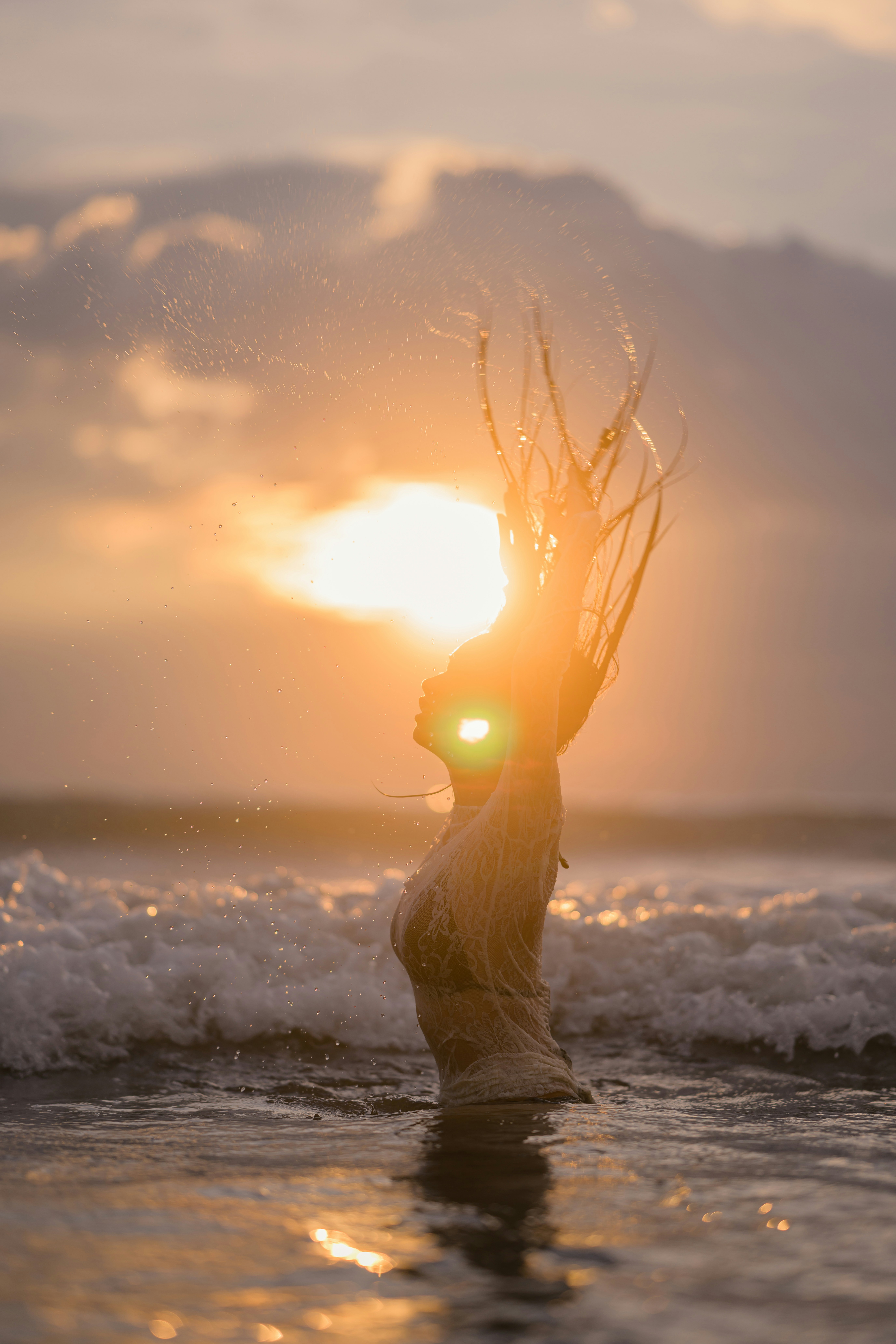Sunset Silhouette: Woman Rising from Tidal Glow