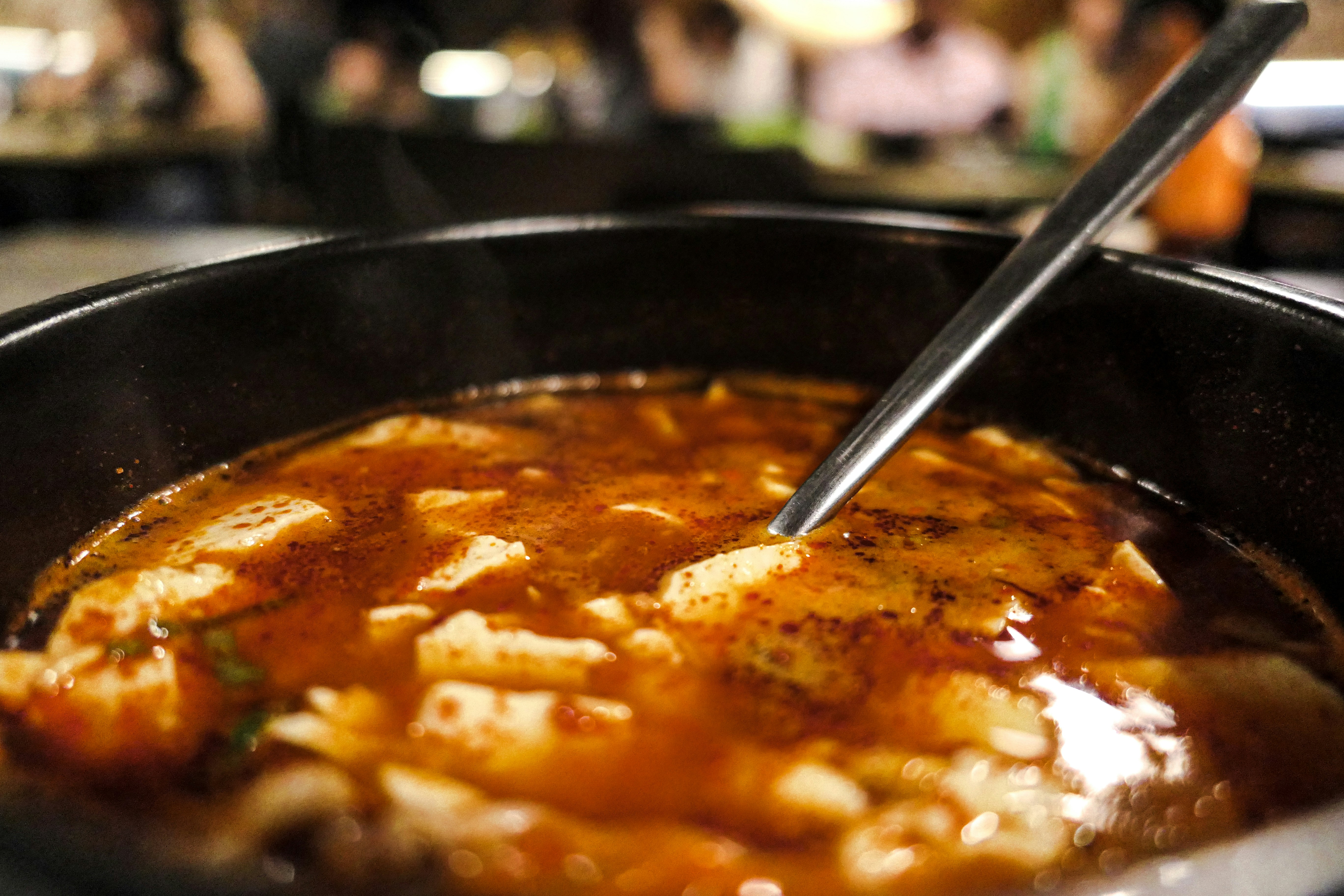 Spoon Resting in a Rich Broth: A Close-Up of Comfort