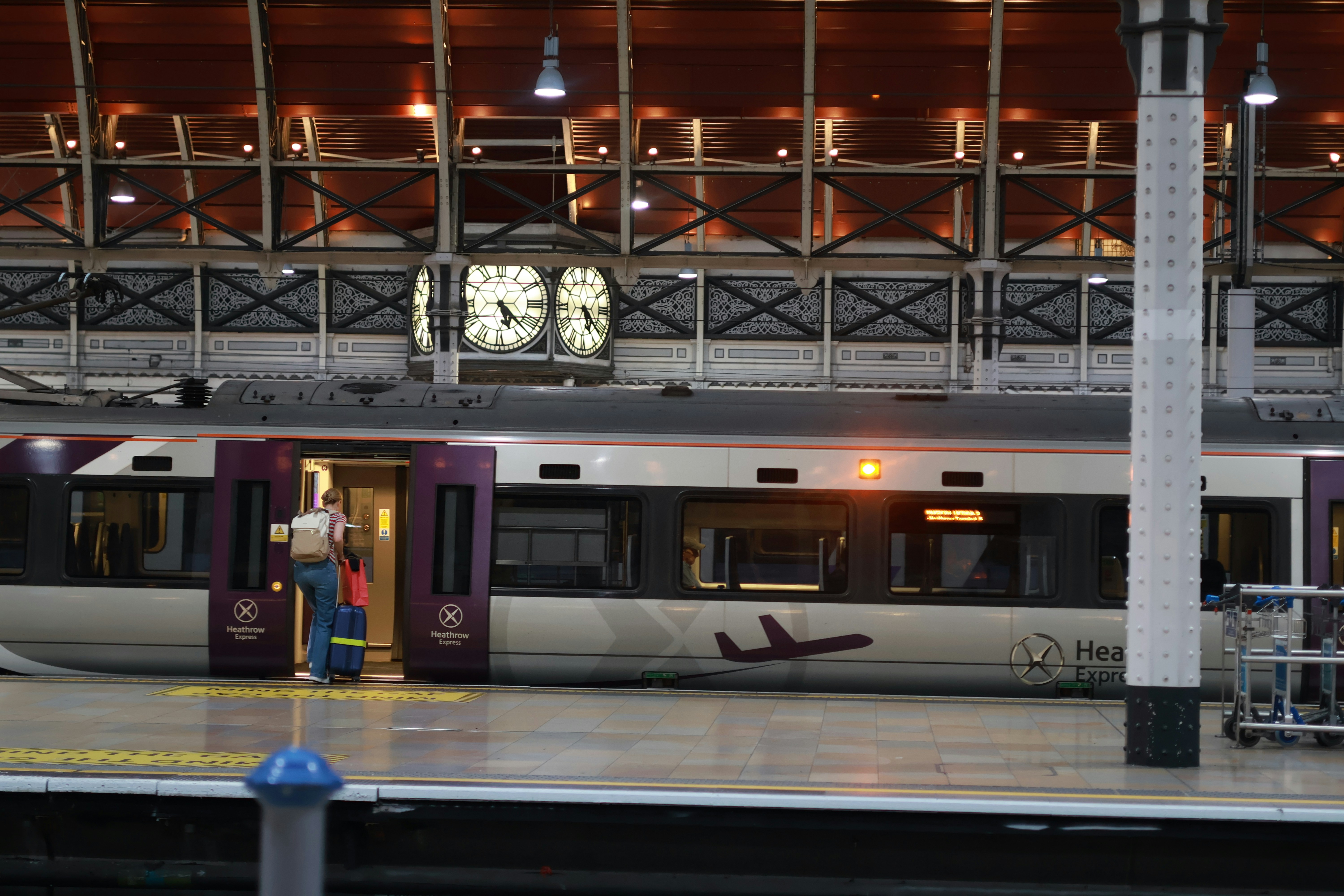 Platform Pulse: Passengers Boarding a Modern Train Under Clocked Night Aglow