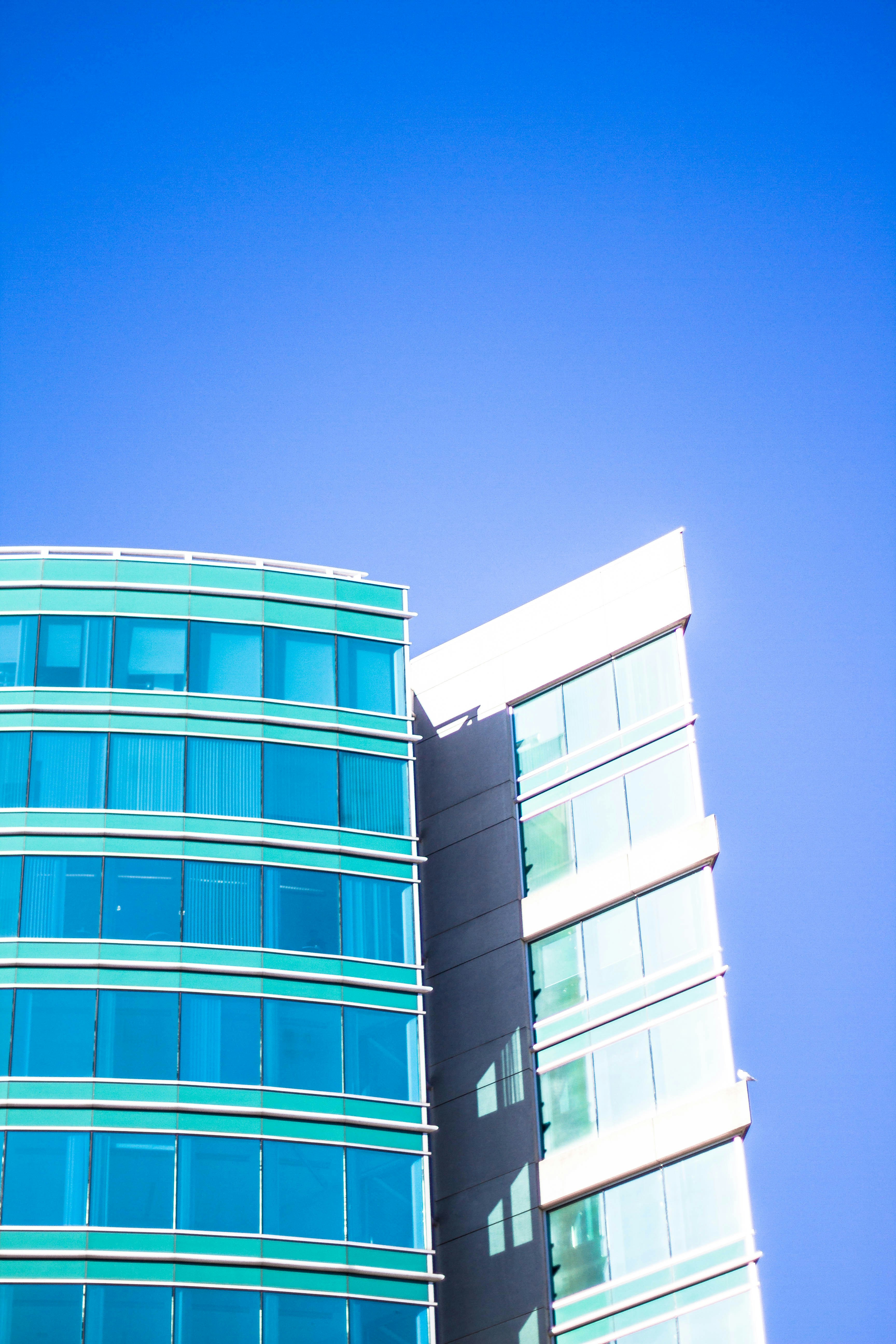 Blue Glass Facade Reaching Toward a Clear Sky