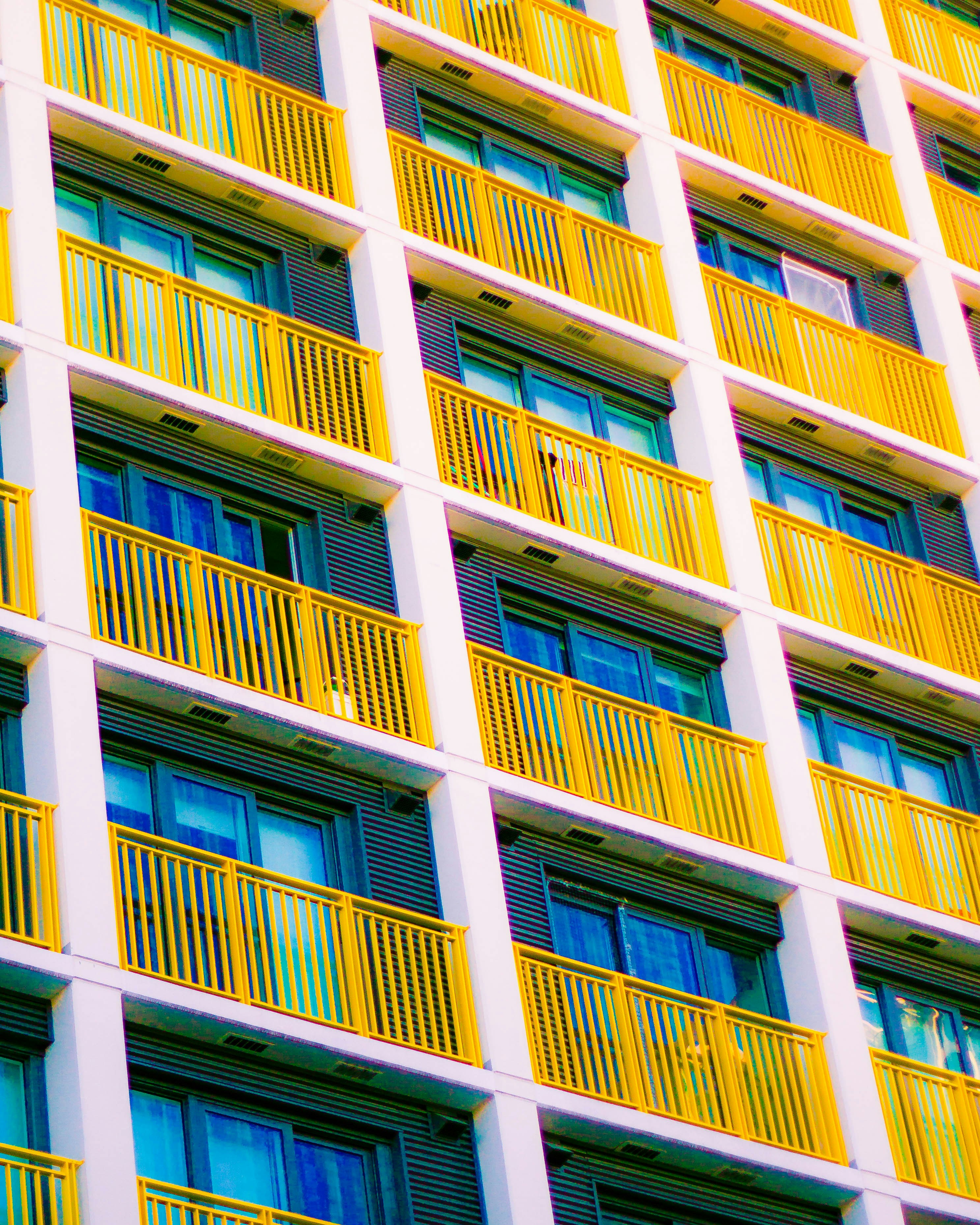 Sunlit Grid: A Looming Patchwork of Yellow Balconies