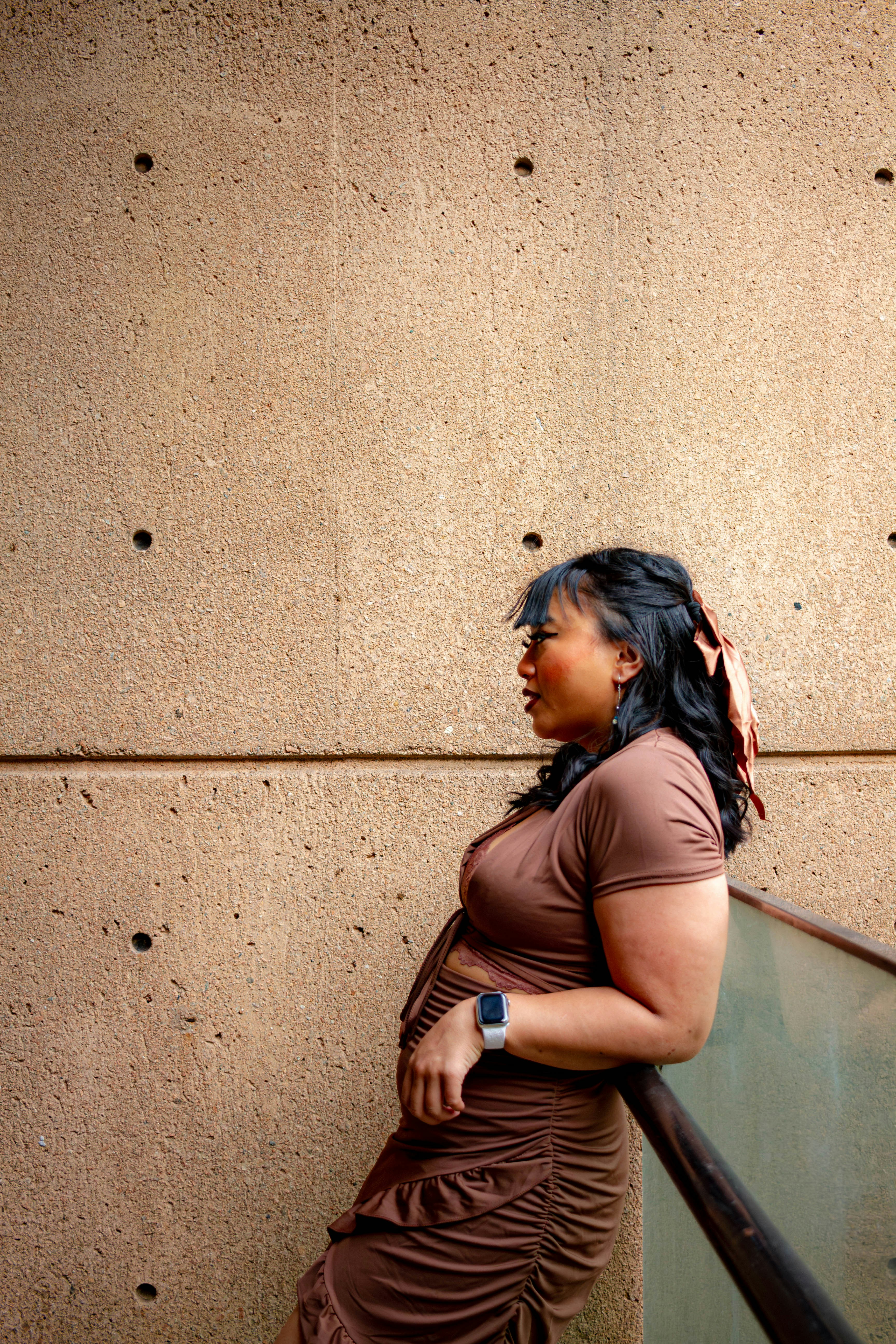 Profile in Warm Light: The Pregnant Silhouette by the Concrete Wall