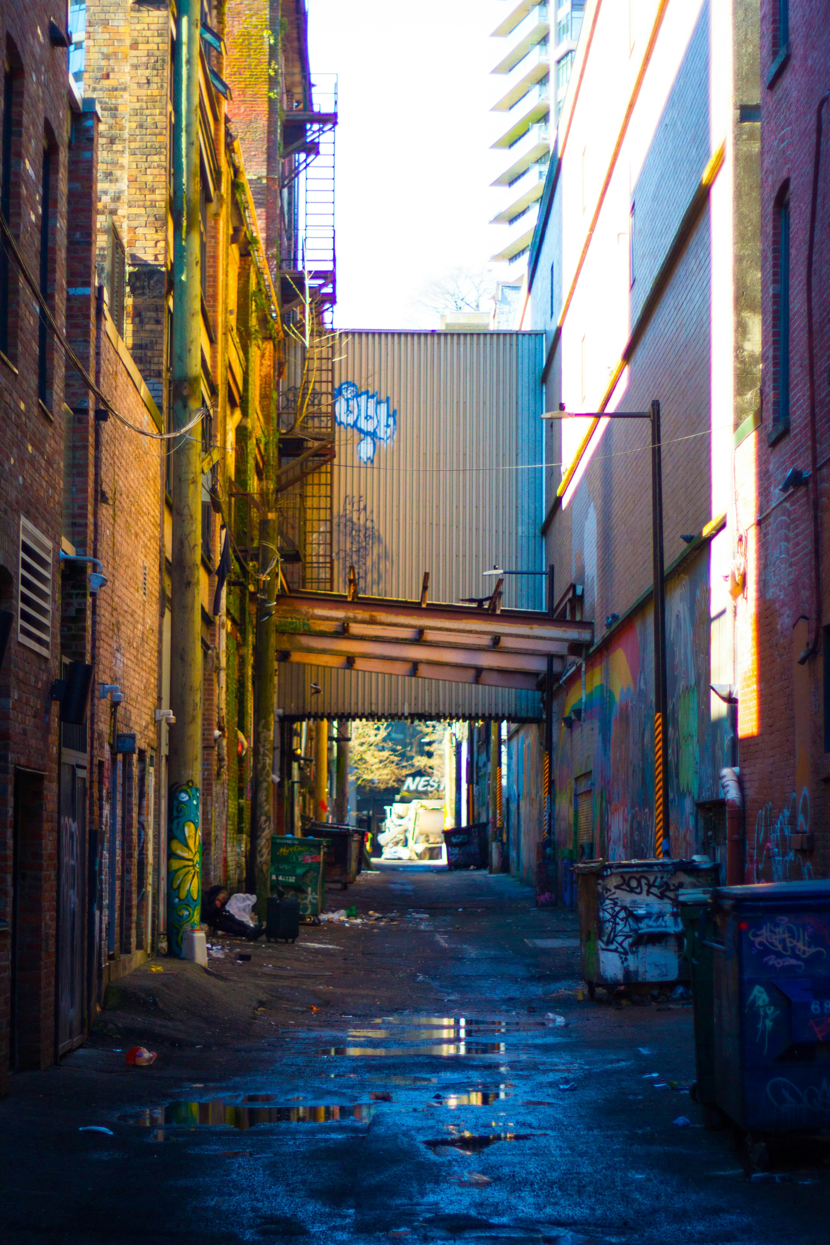 Urban Alley Archway: Light at the End of a Painted Corridor