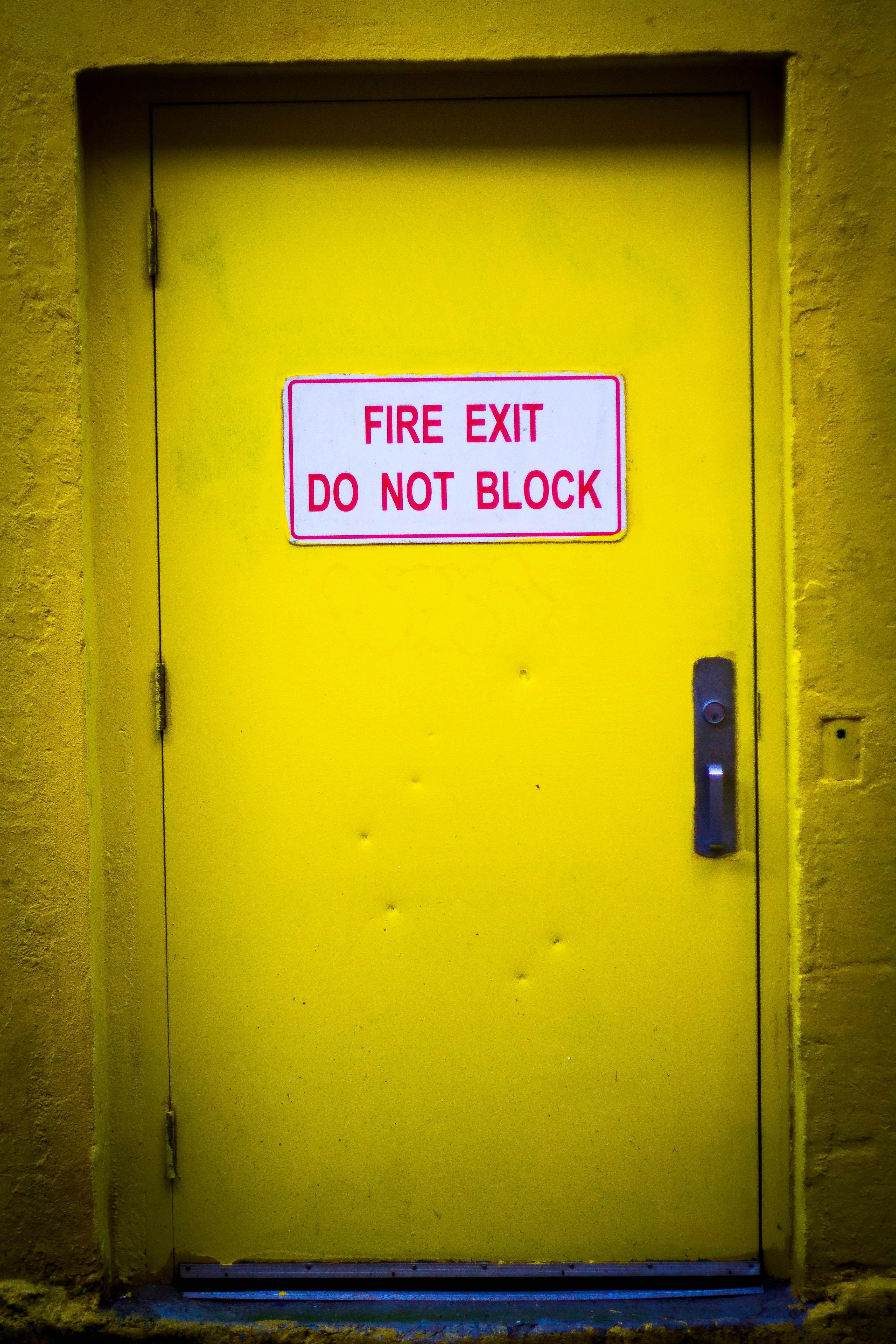 Yellow Fire Exit Door Dominates the Frame