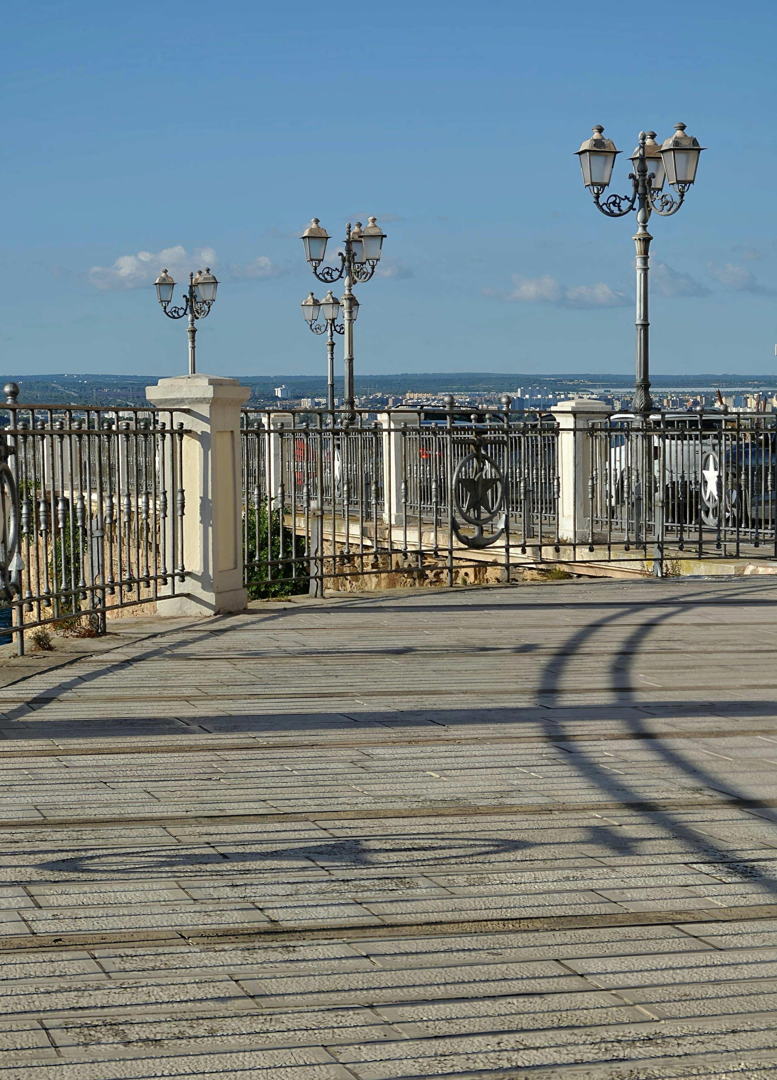 Urban Promenade at Distant City Horizon with Ornate Lamp Posts