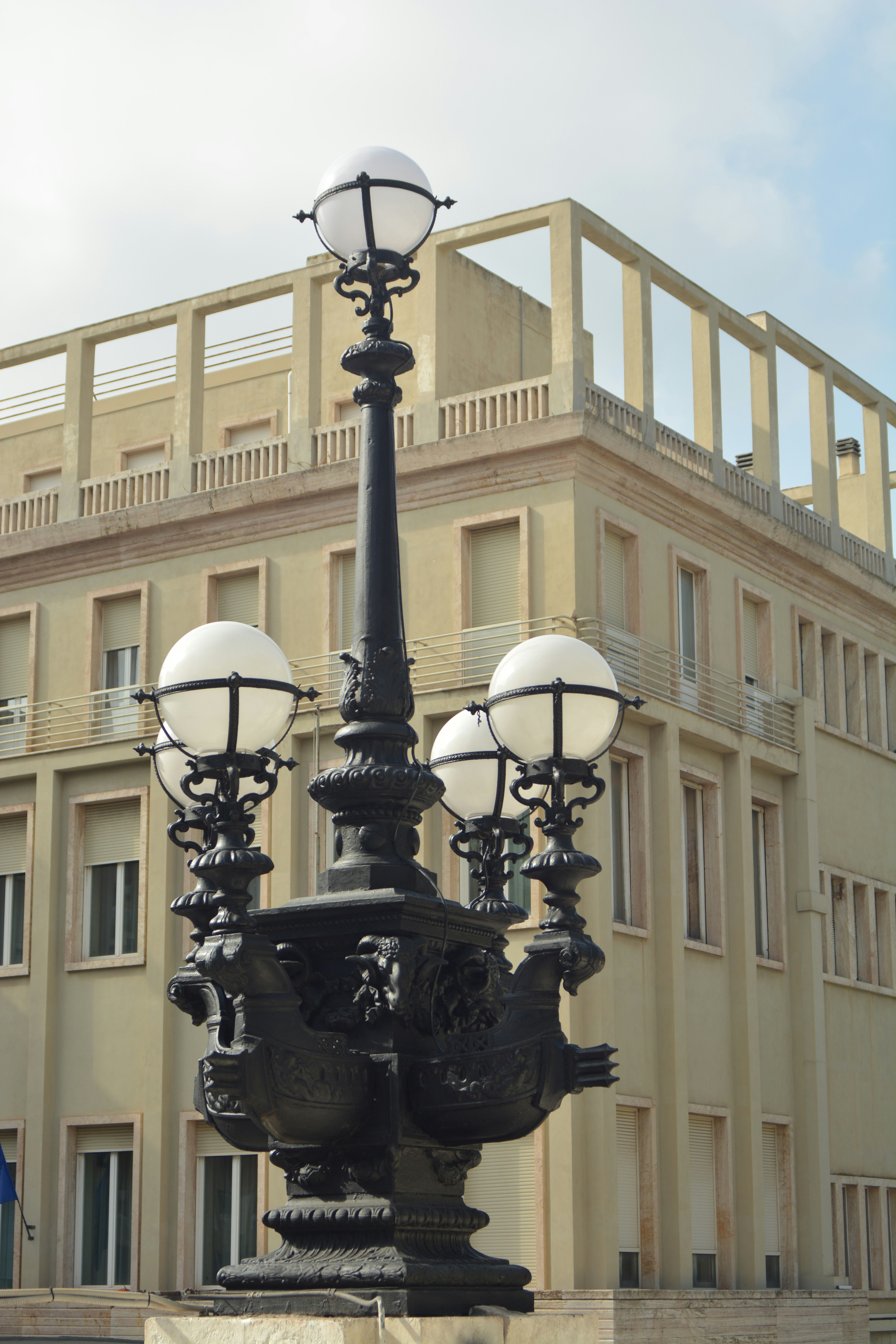 Ornate Street Lamp Ensemble Against Neoclassical Facade