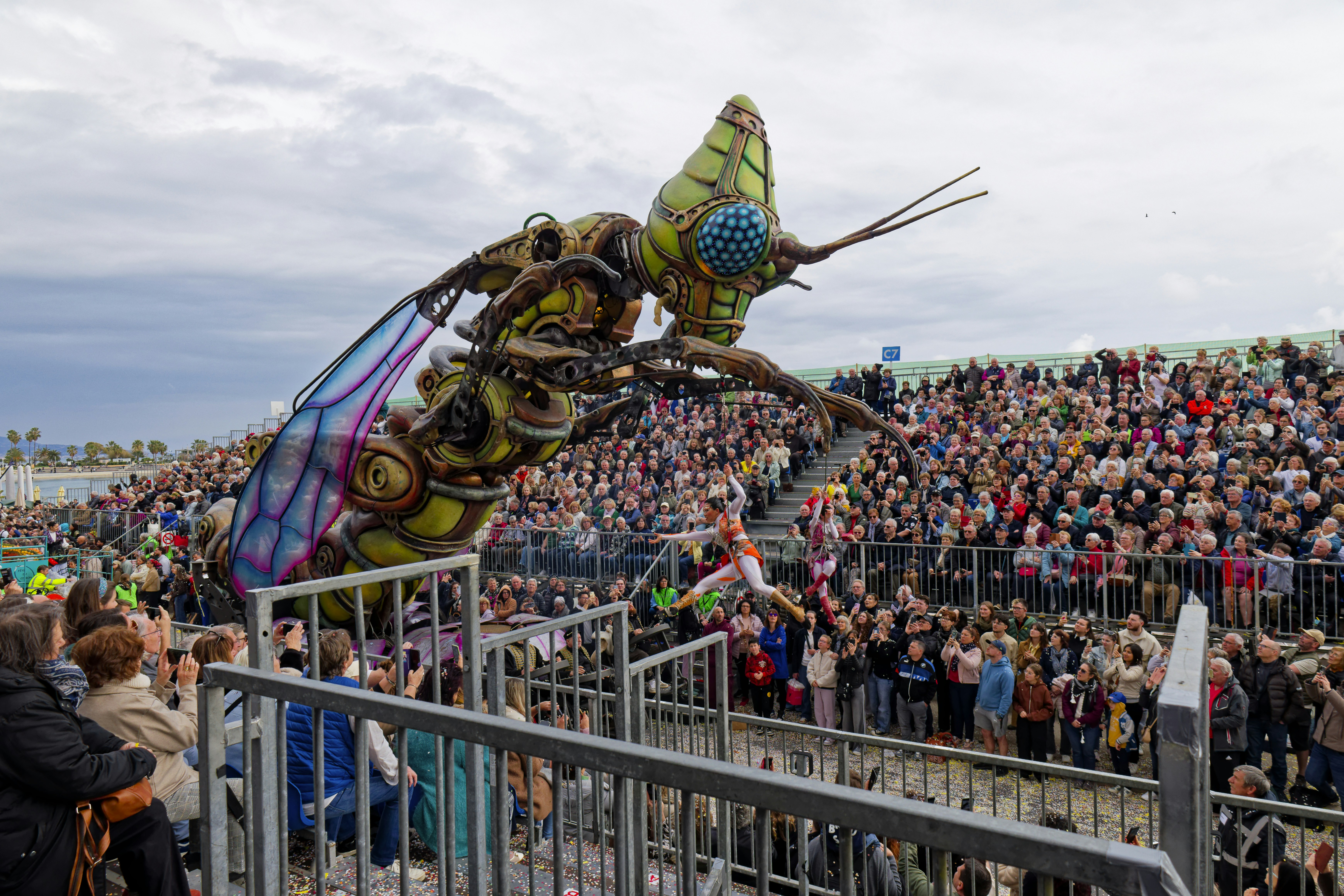 Giant insect-marionette lands among cheering crowd