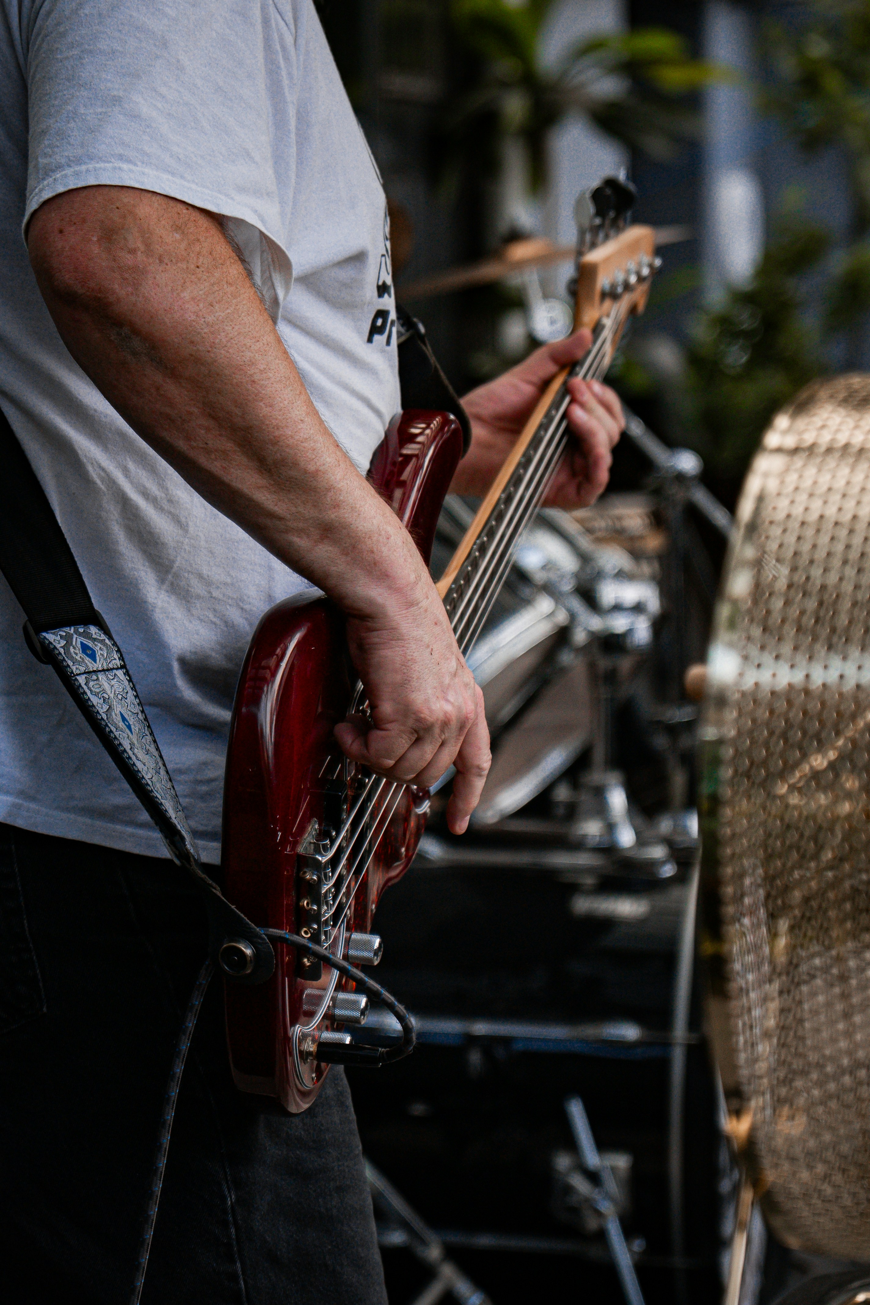Low-angled Groove: A guitarist mid-riff in a sunlit street setup