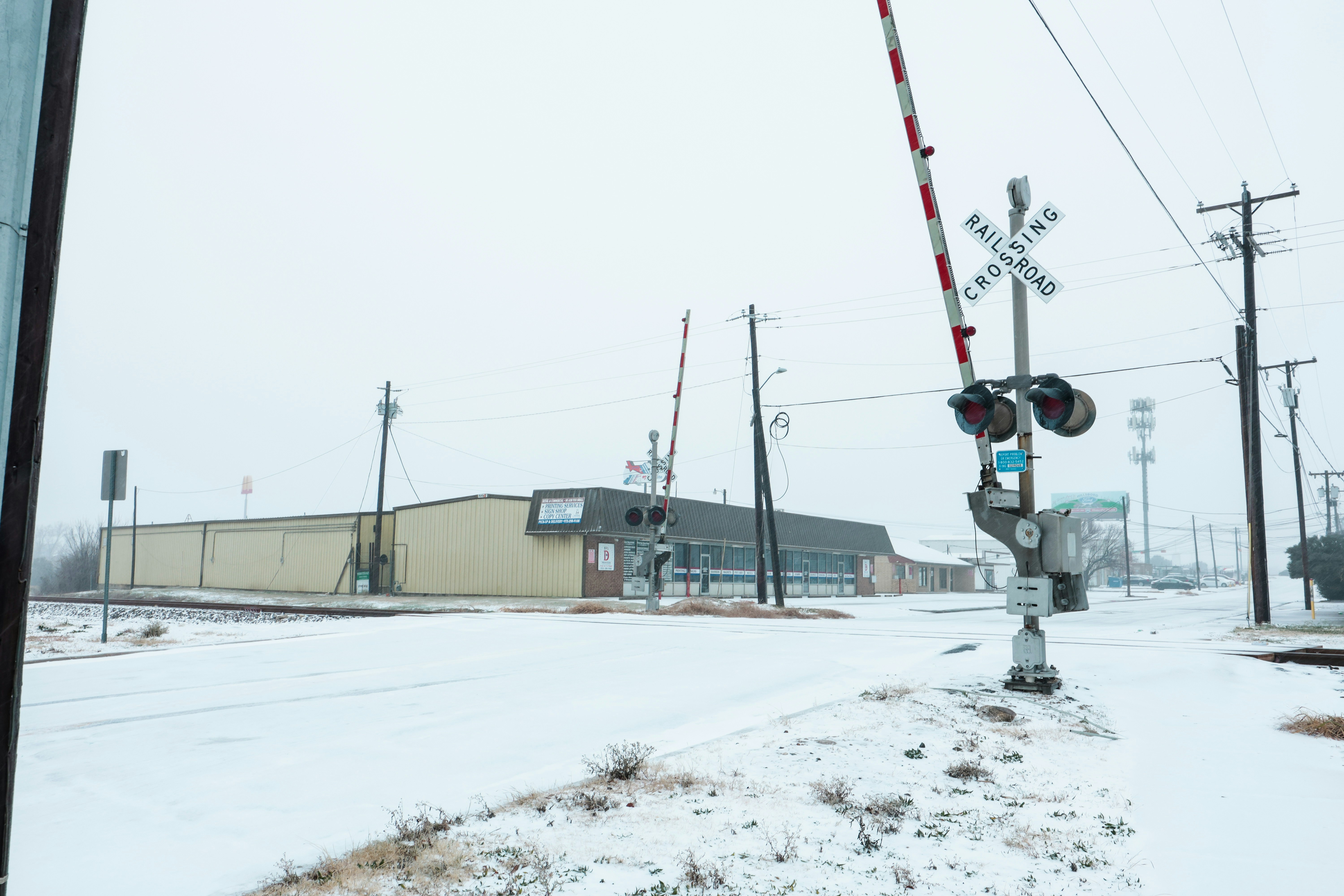 Snowbound Crossing: The Quiet Rail Yard at Dusk
