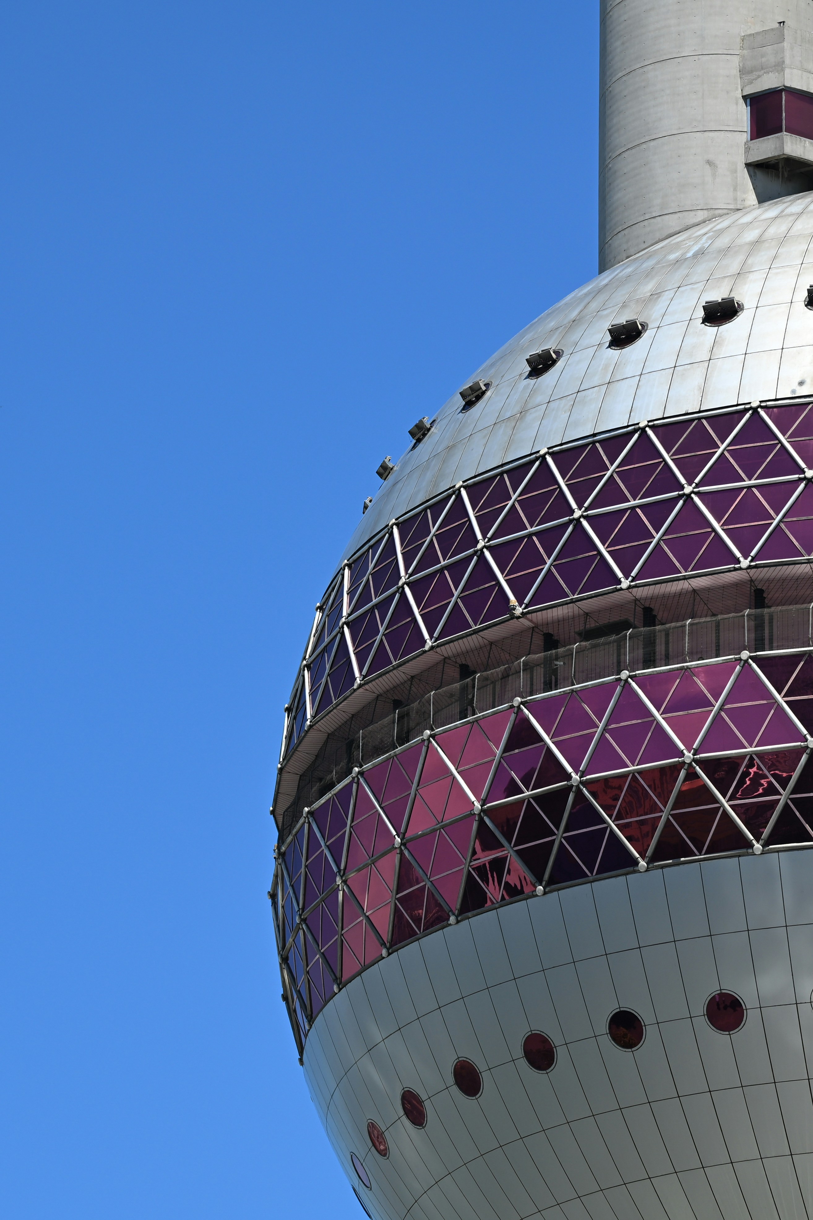 Geometric Sphere: A Glint of Purple Between Steel and Sky