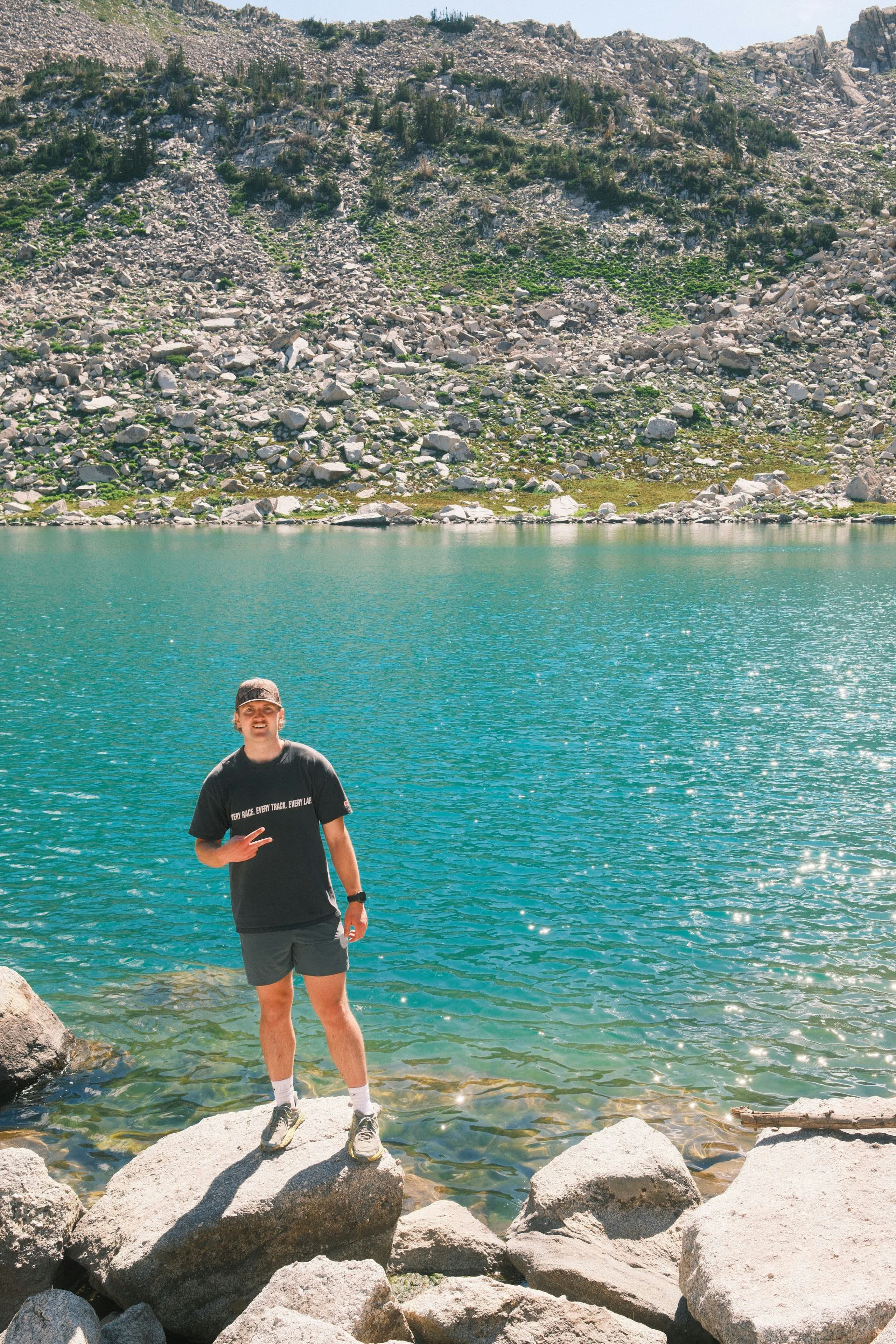 Hero on the Shore: A Lone Hiker at Turquoise Alpine Lake