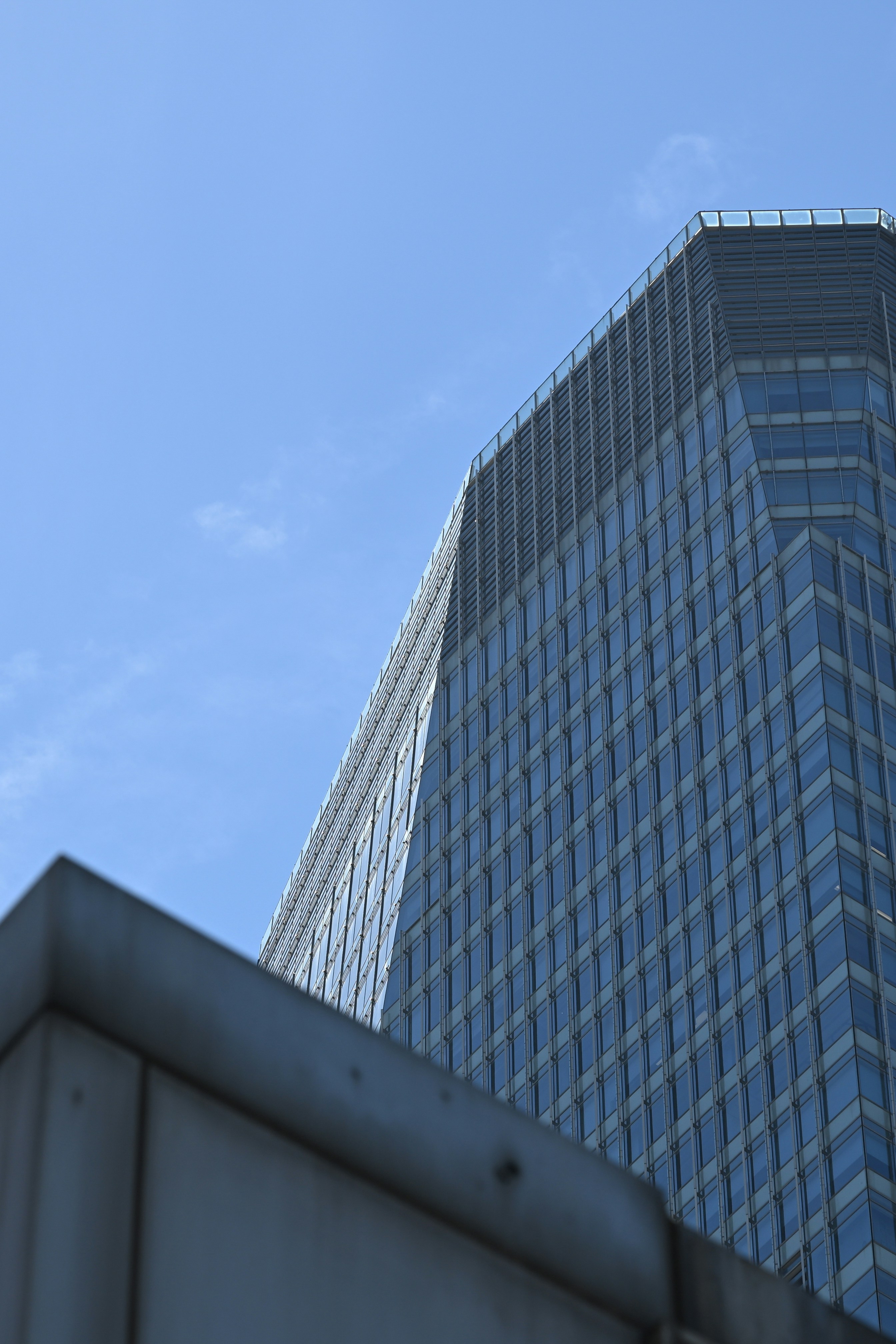 Angular Skyline: The Corner of a Sky-Soaked Glass Tower