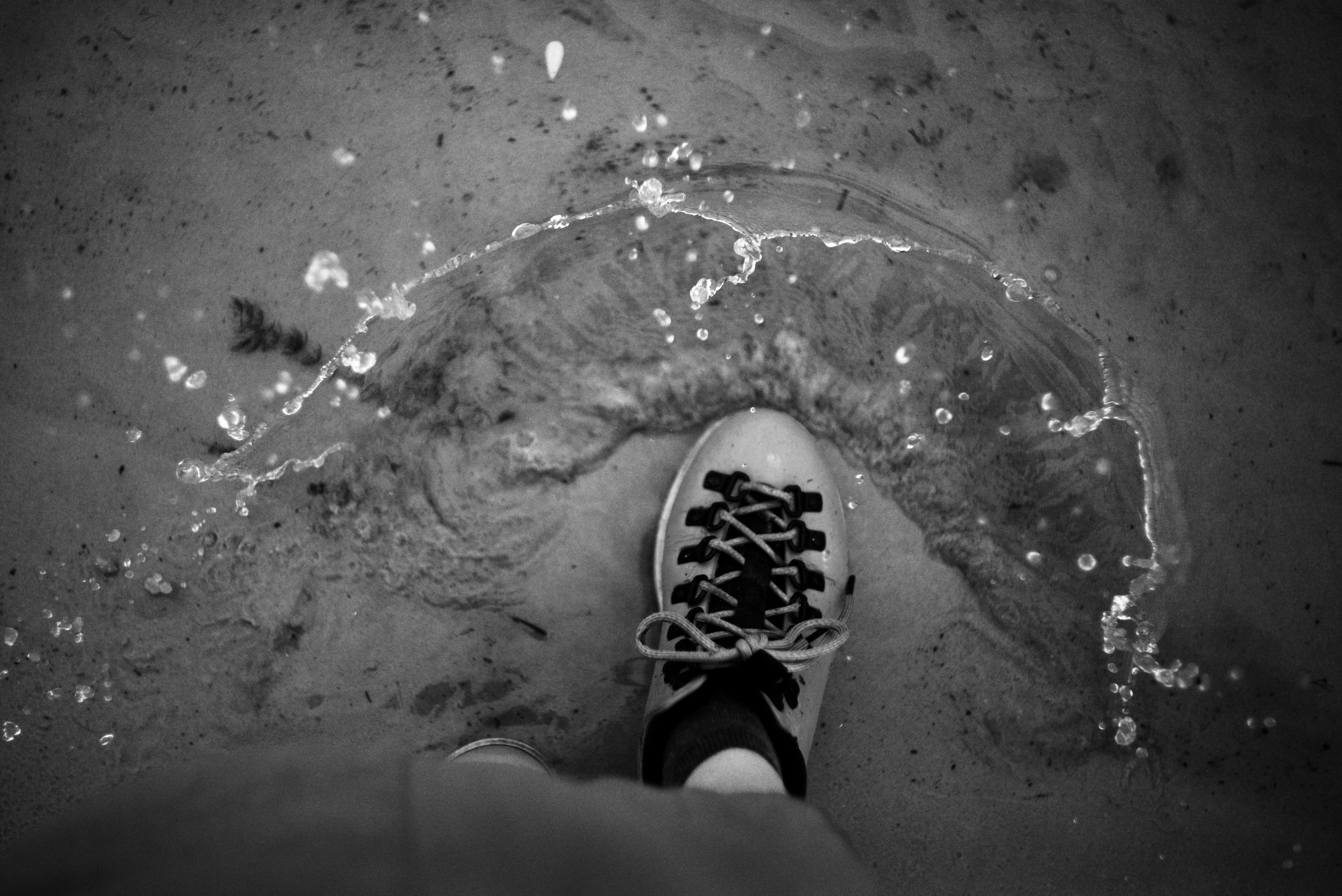 Step Through the Tide: A Single Footprint in Monochrome Mud