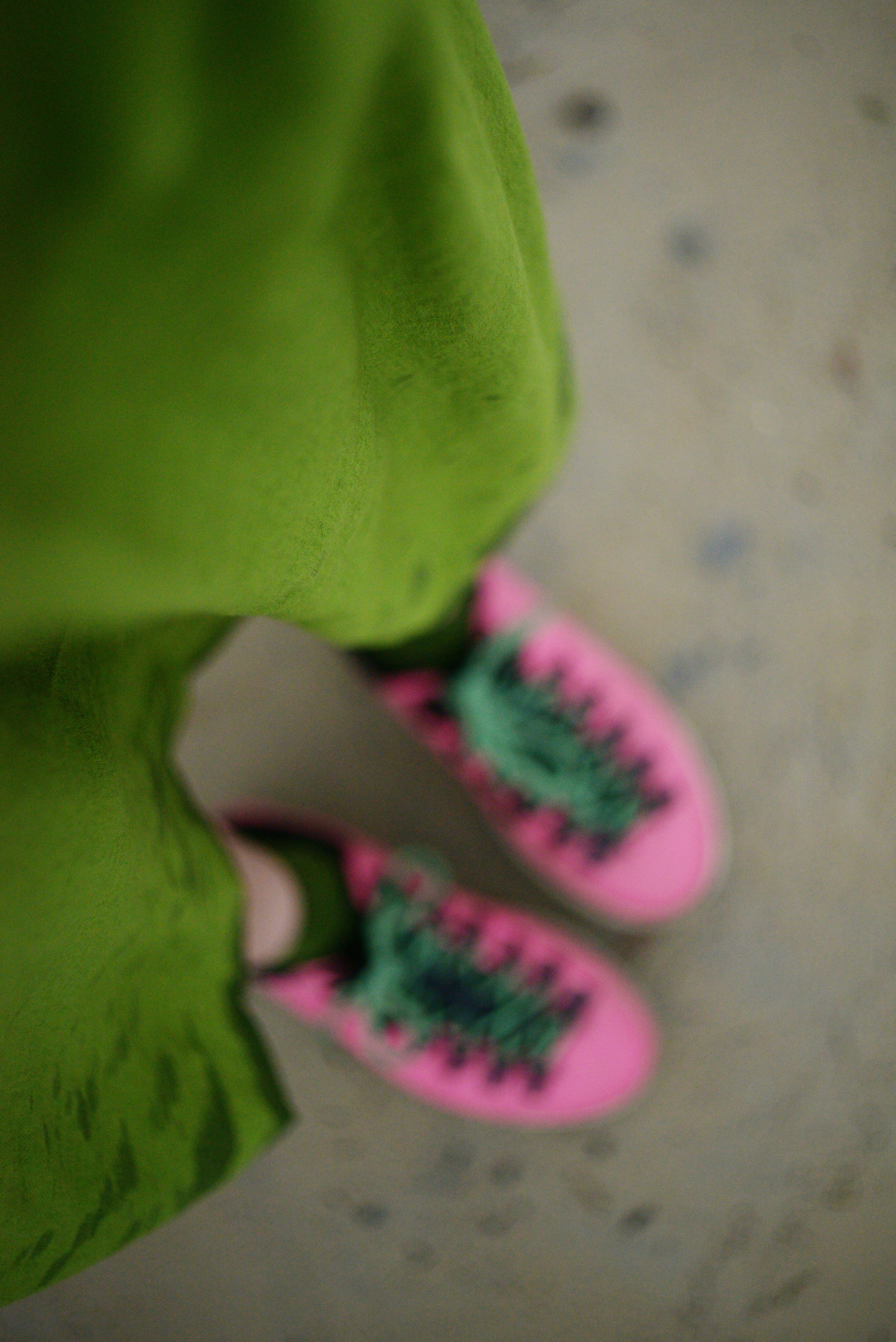 Neon sneakers under a lime-green garment