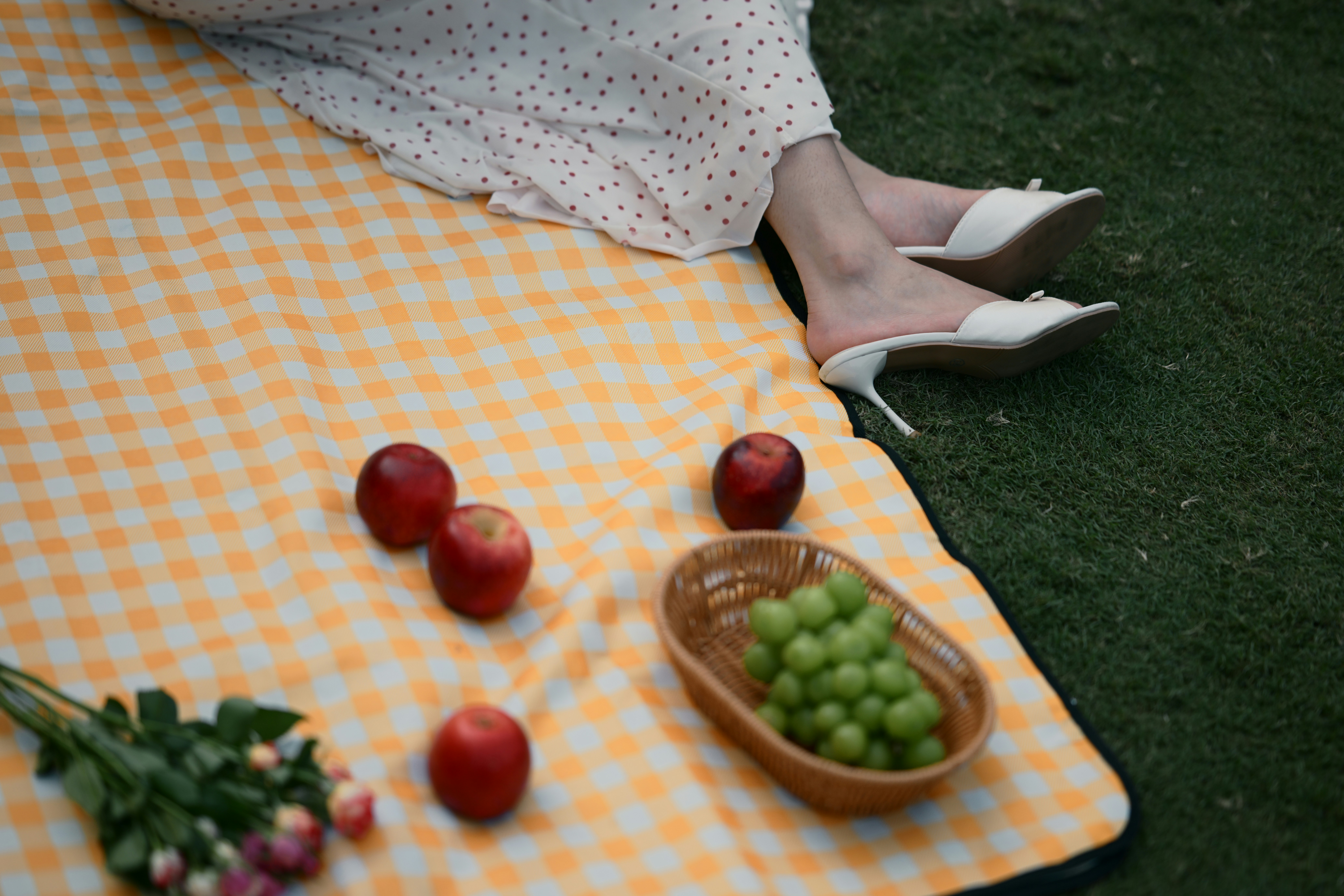 Gently Draped Picnic: White Heels by a Sunlit Orange Blanket