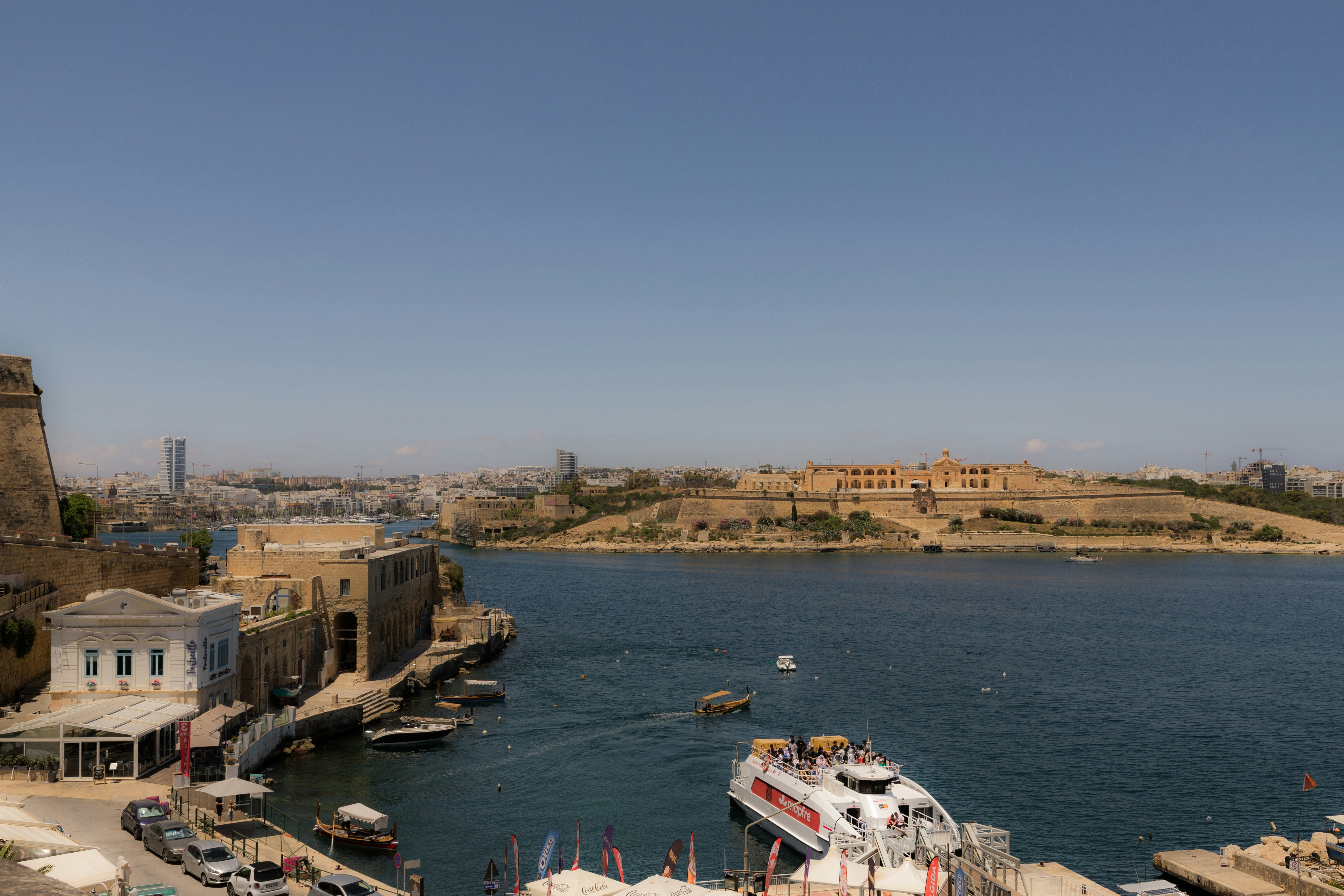 Harbor Panorama: Boats at Dock Beneath a Golden Citadel