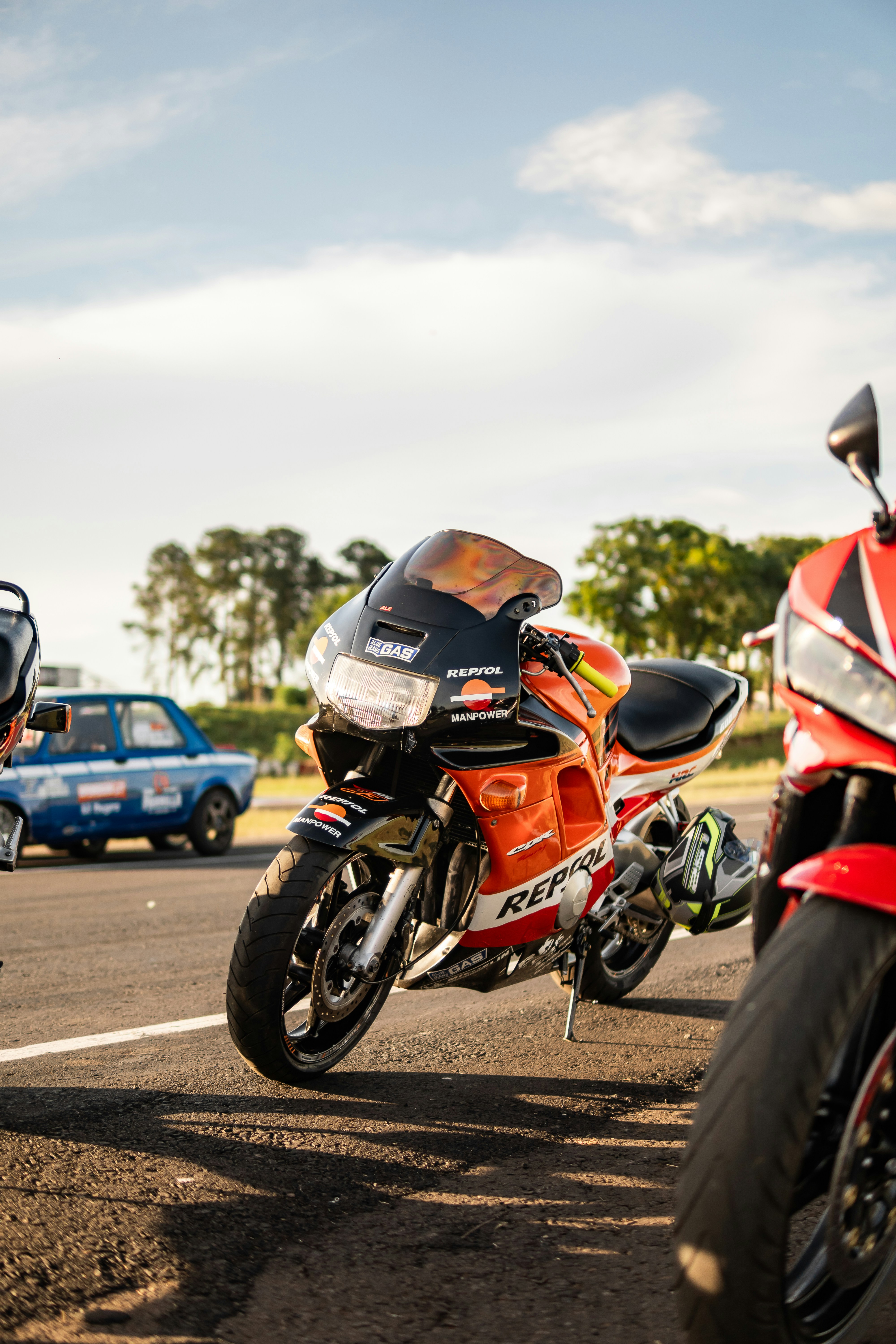 Orange Repsol Racer in the Paddock: Sharp Focus on a Moto Moment