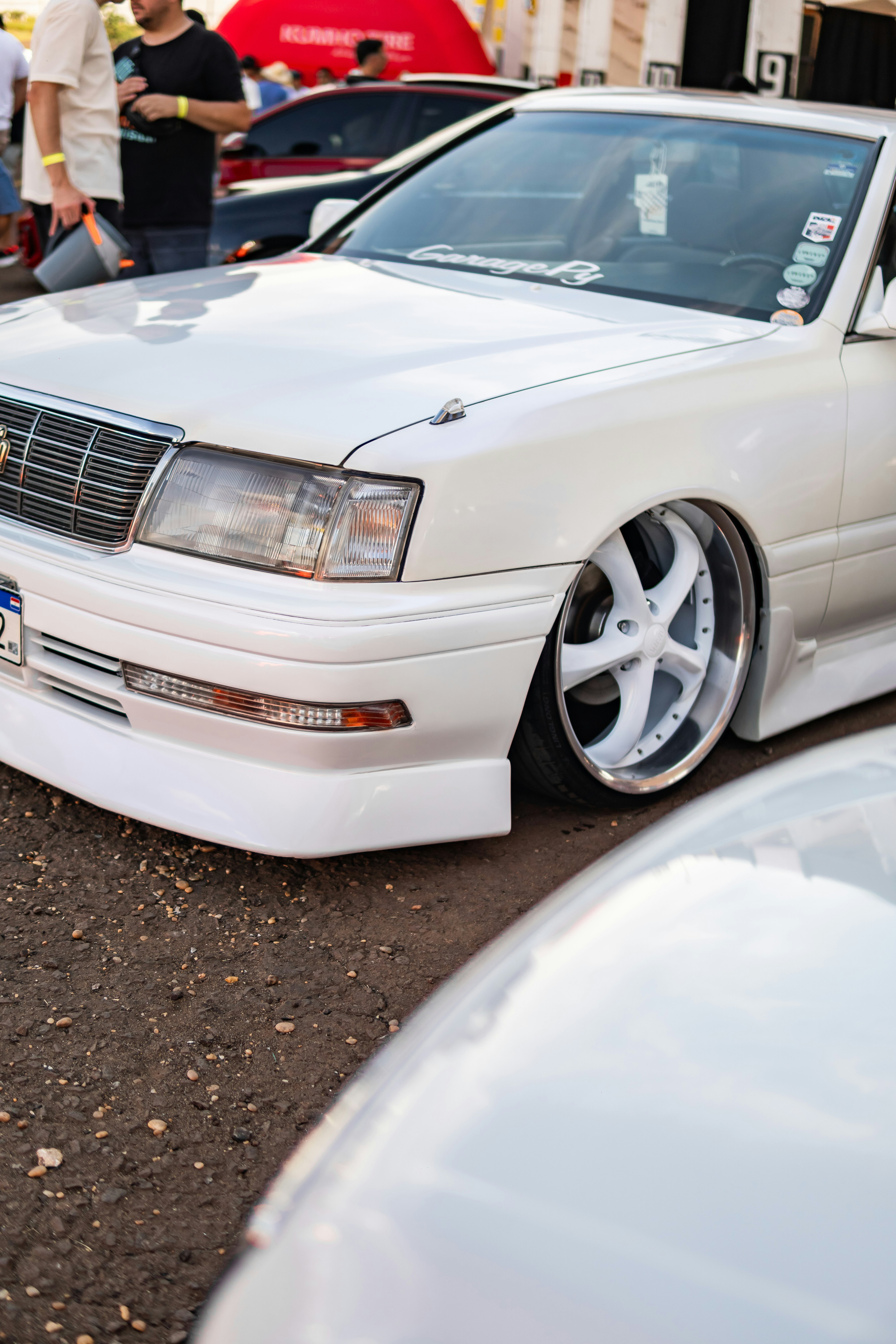 Low-Slung White Classic at a Car Show