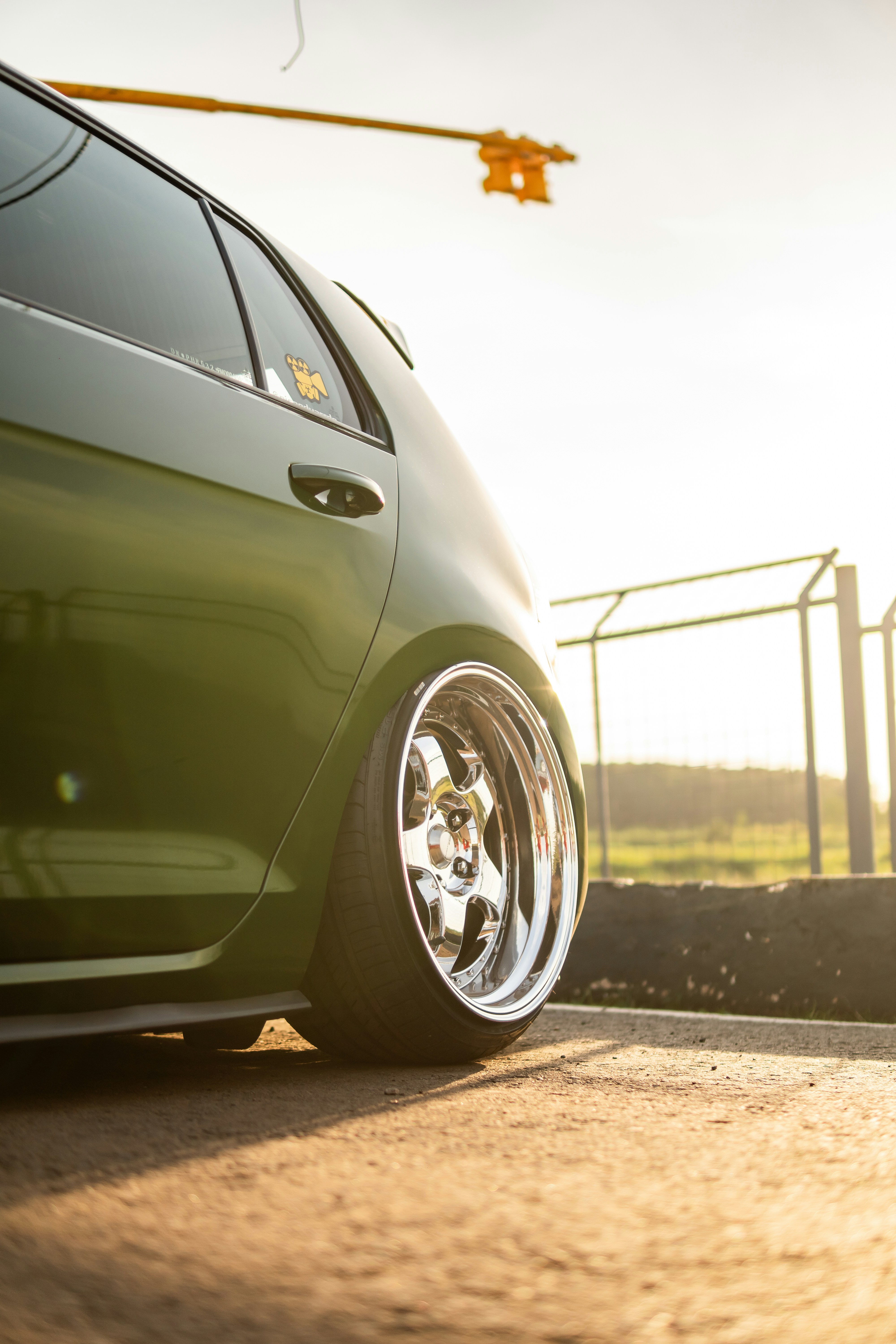 Low-angle Green: A Stance of Wheel and Rim at Dusk