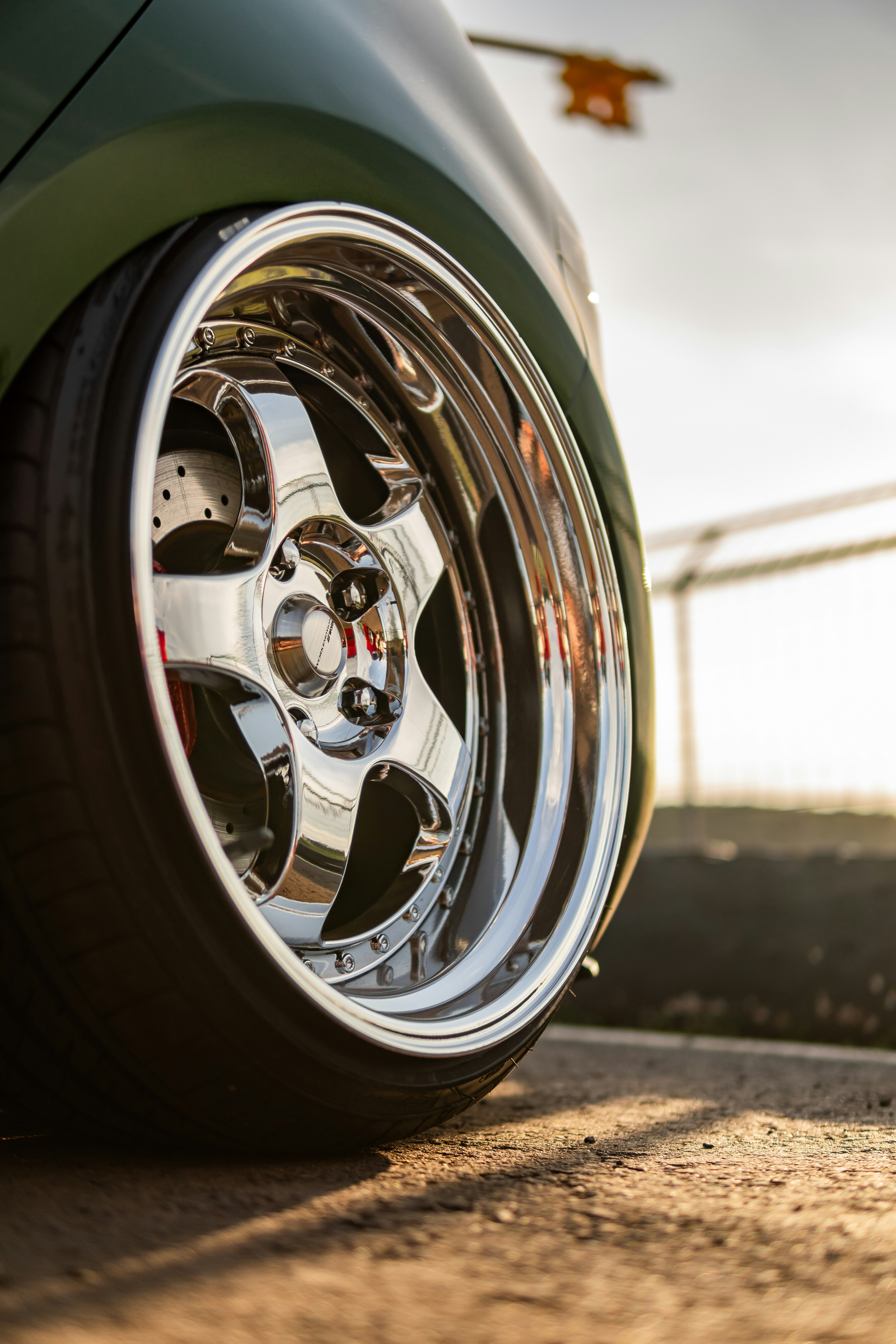 Chromed Wheel Reverie: A Low-Angle Gaze at a Shiny Car