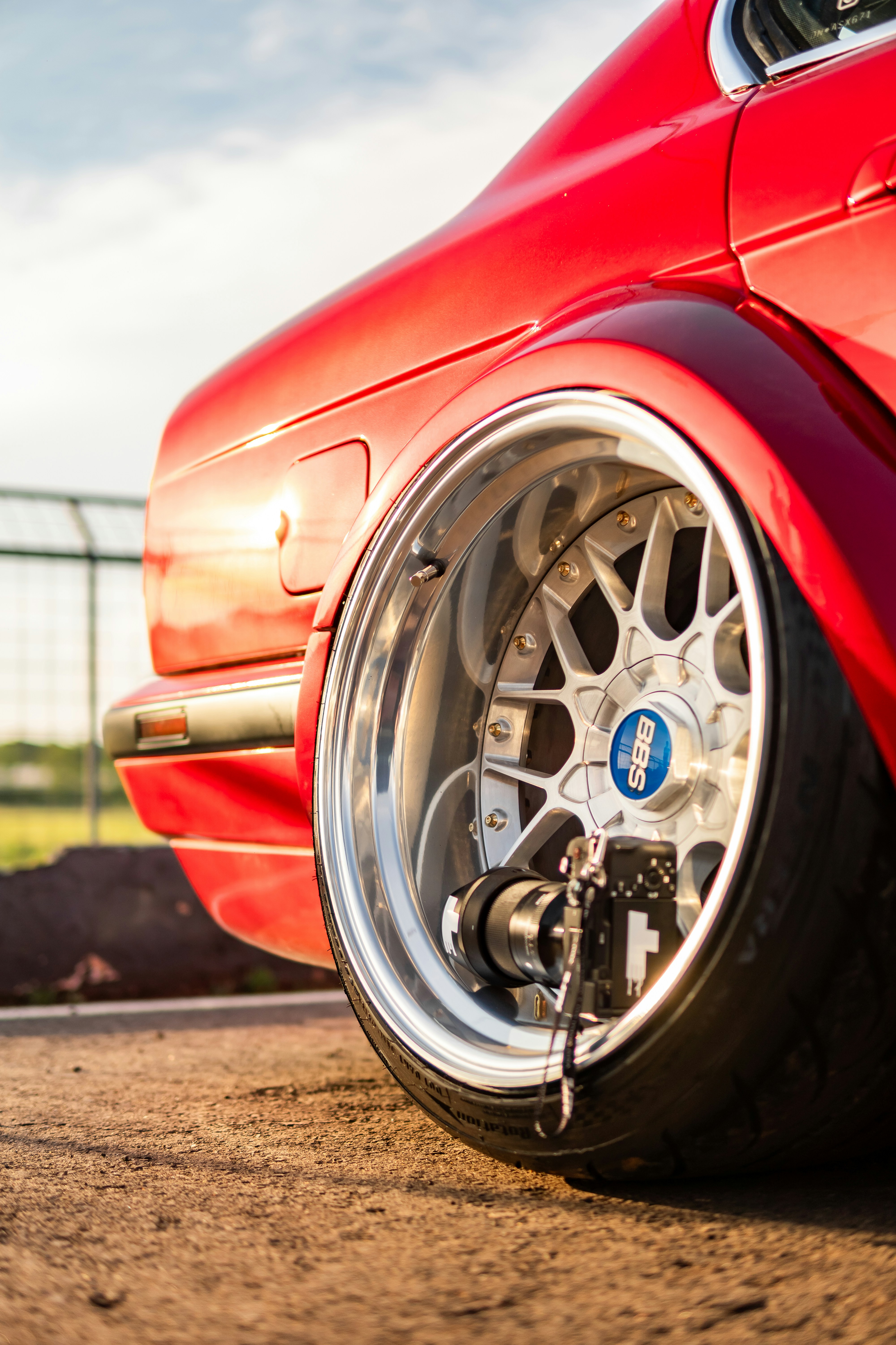 Low-Angle Portrait of a Stretched Red Wheel and Rim Detail
