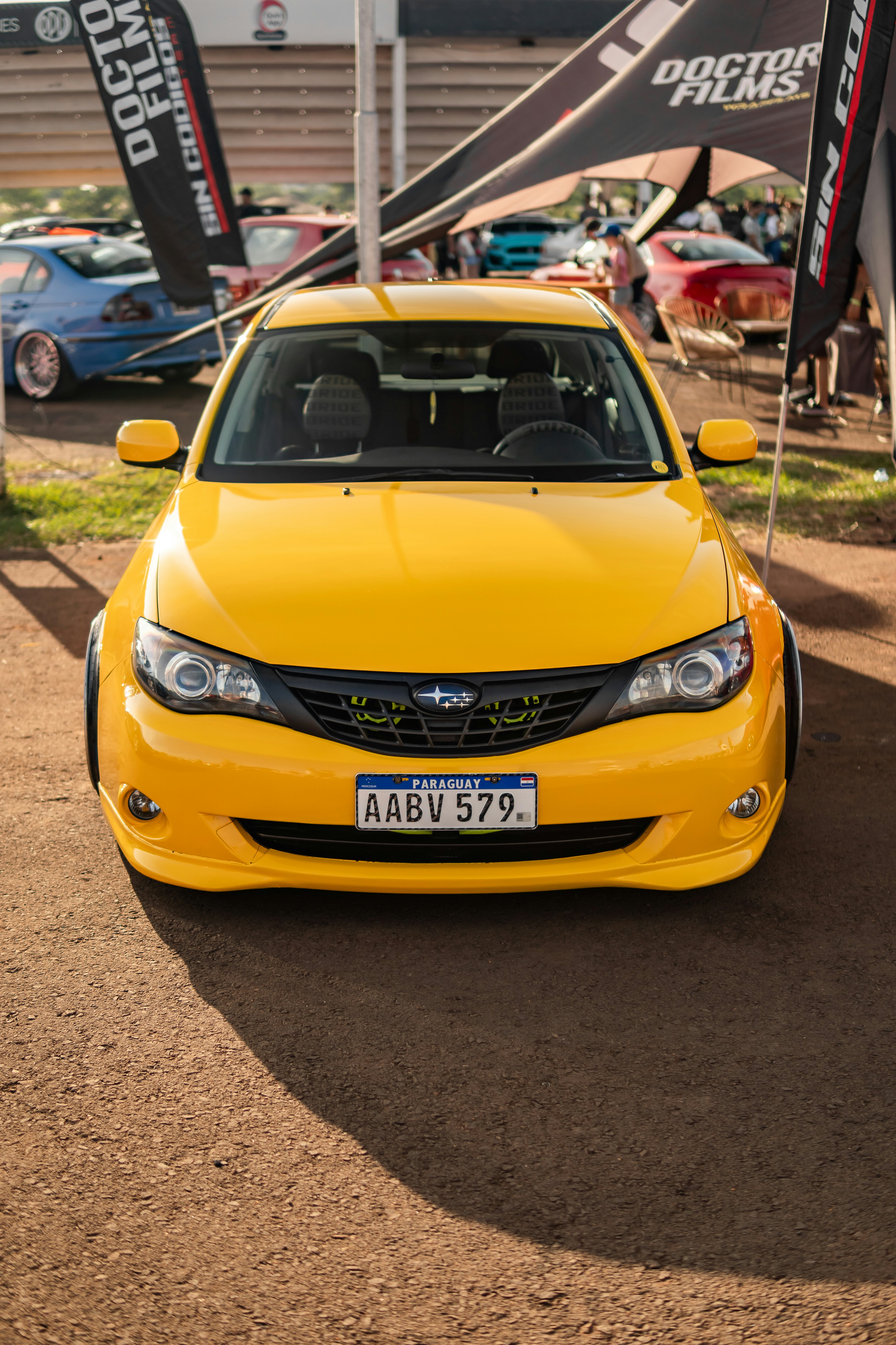 Golden Bold: Front-Row View of a Yellow Taxi at Car Show