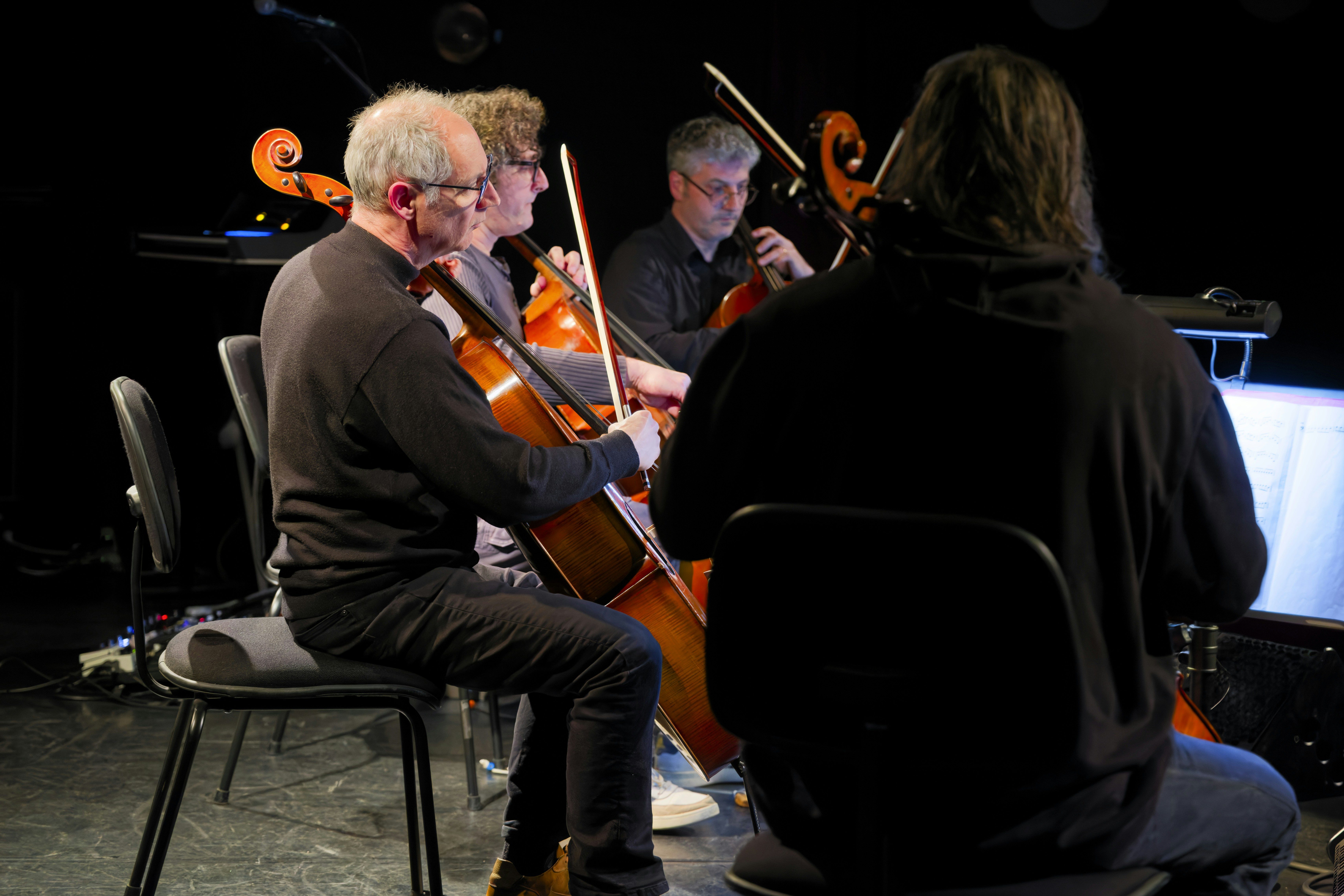 String Ensemble in a Dimmed Rehearsal Hall
