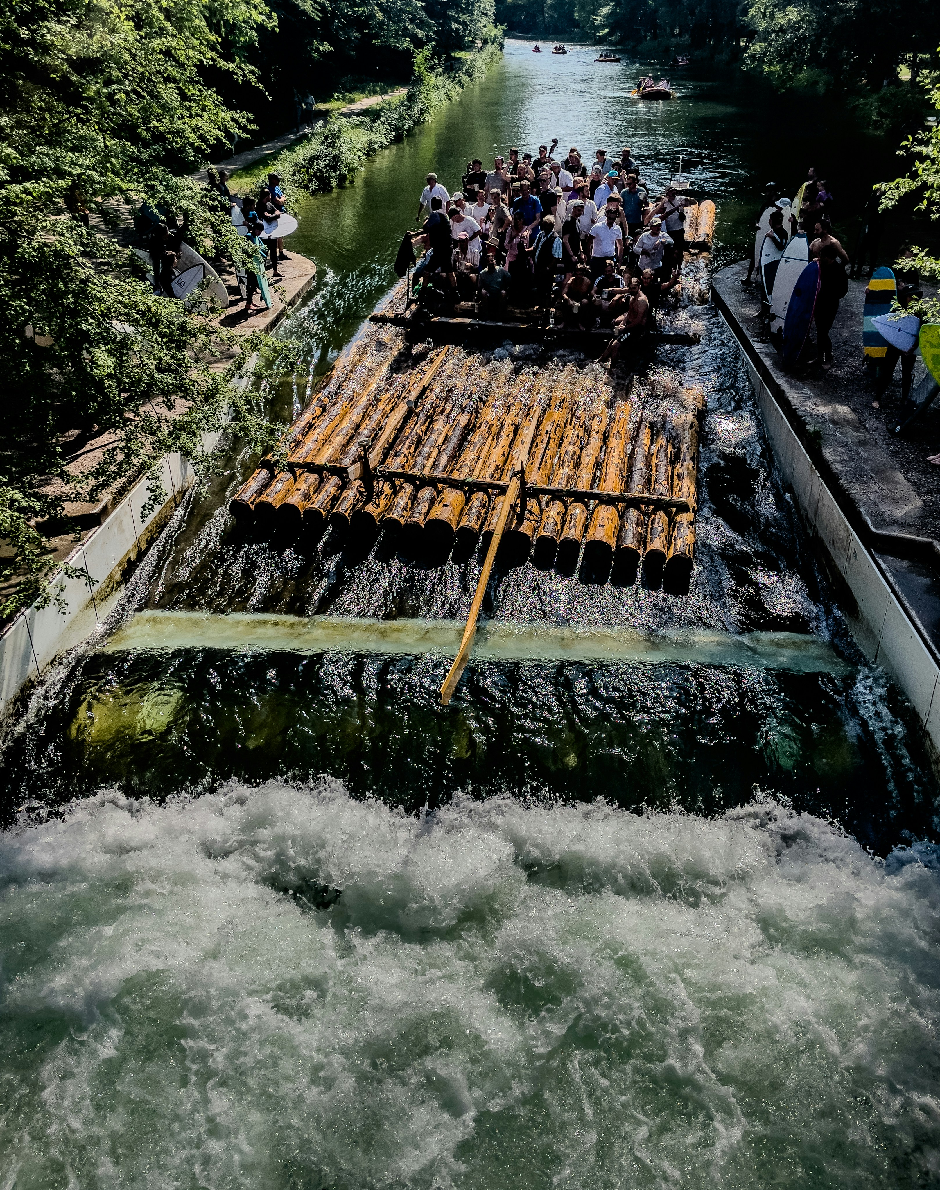 Rafters Converge on a Makeshift Dam Under Sunlit Canopy