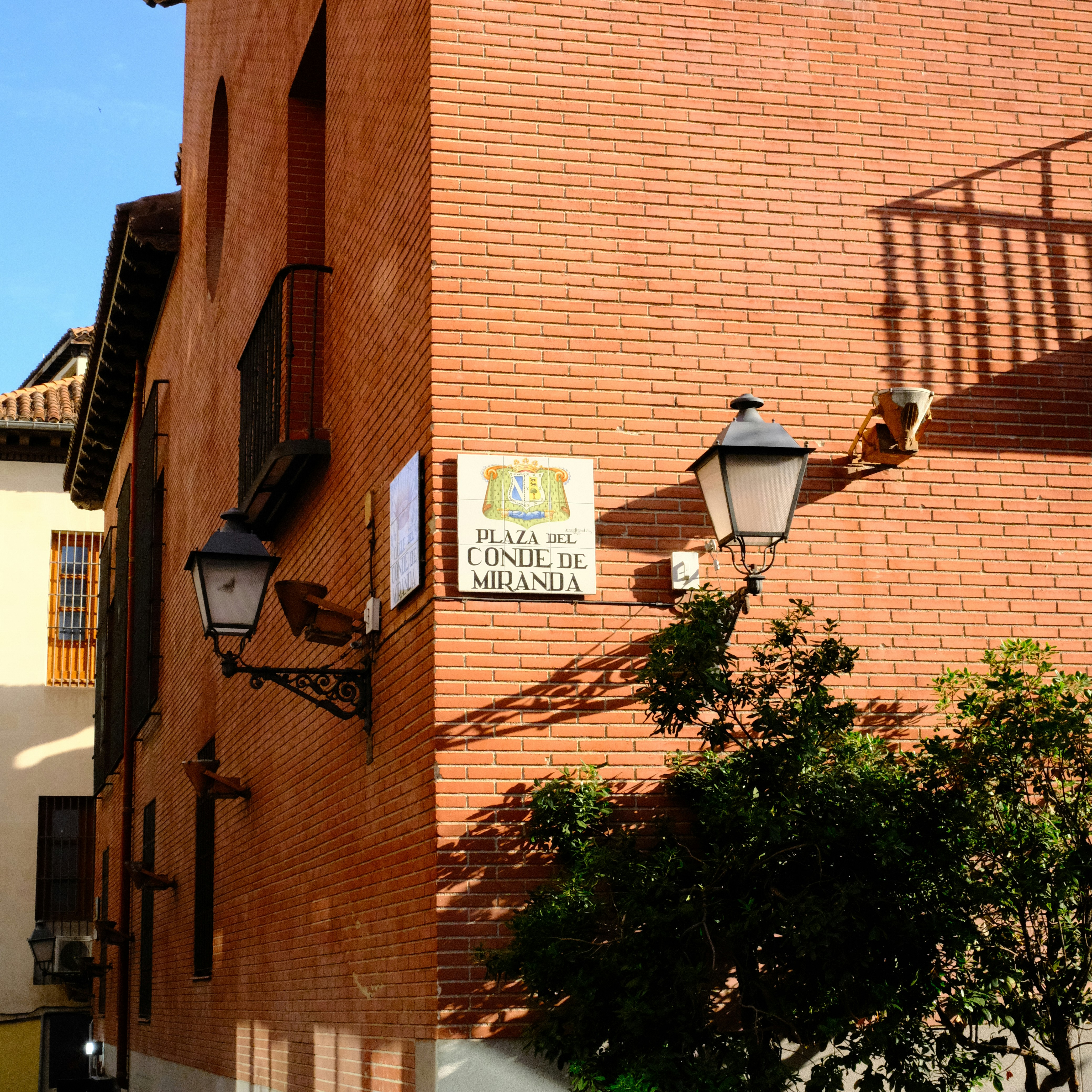 Terracotta Facade and Lanterns on a Sunny Plaza