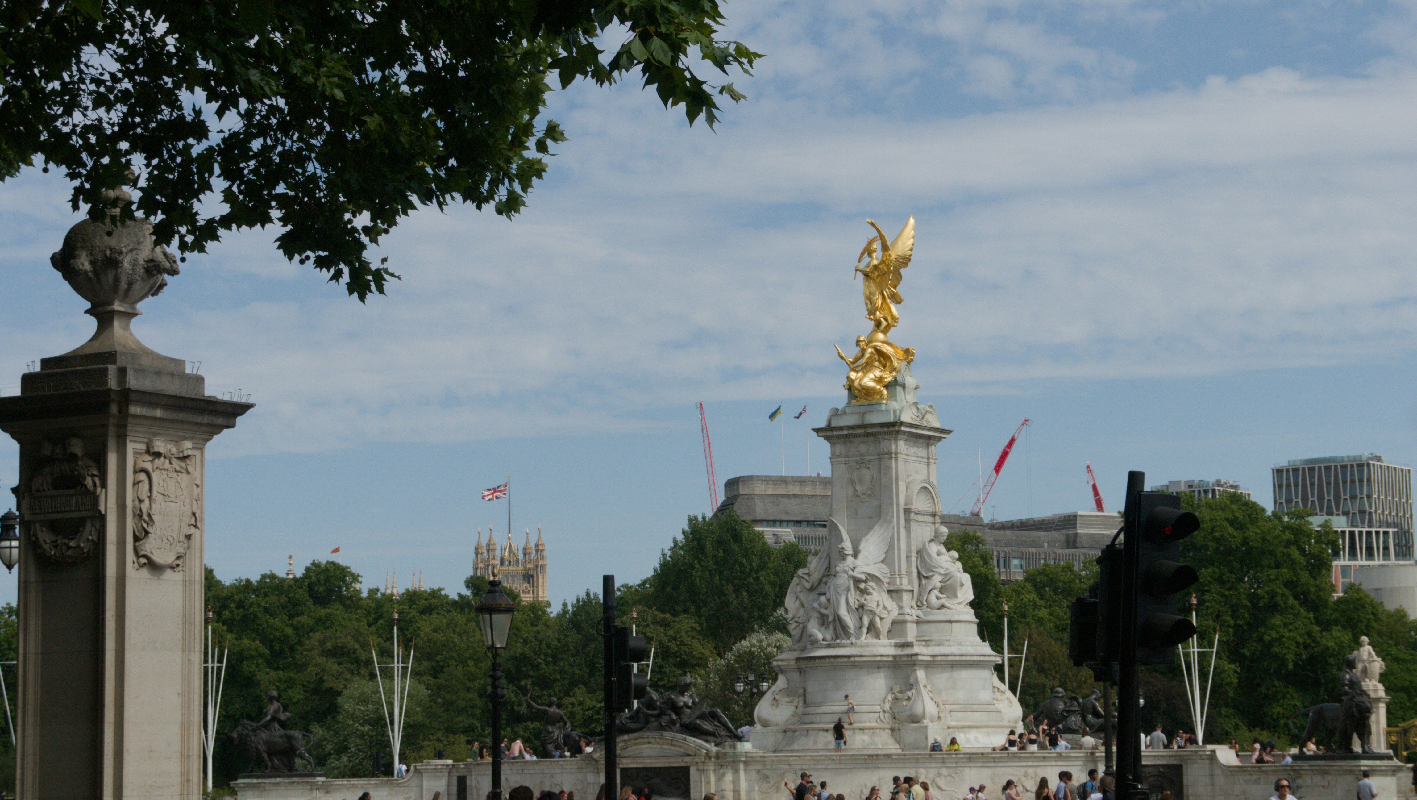 Golden Statue Guarding the Mall: A Monumental Center Framed by City Arcades