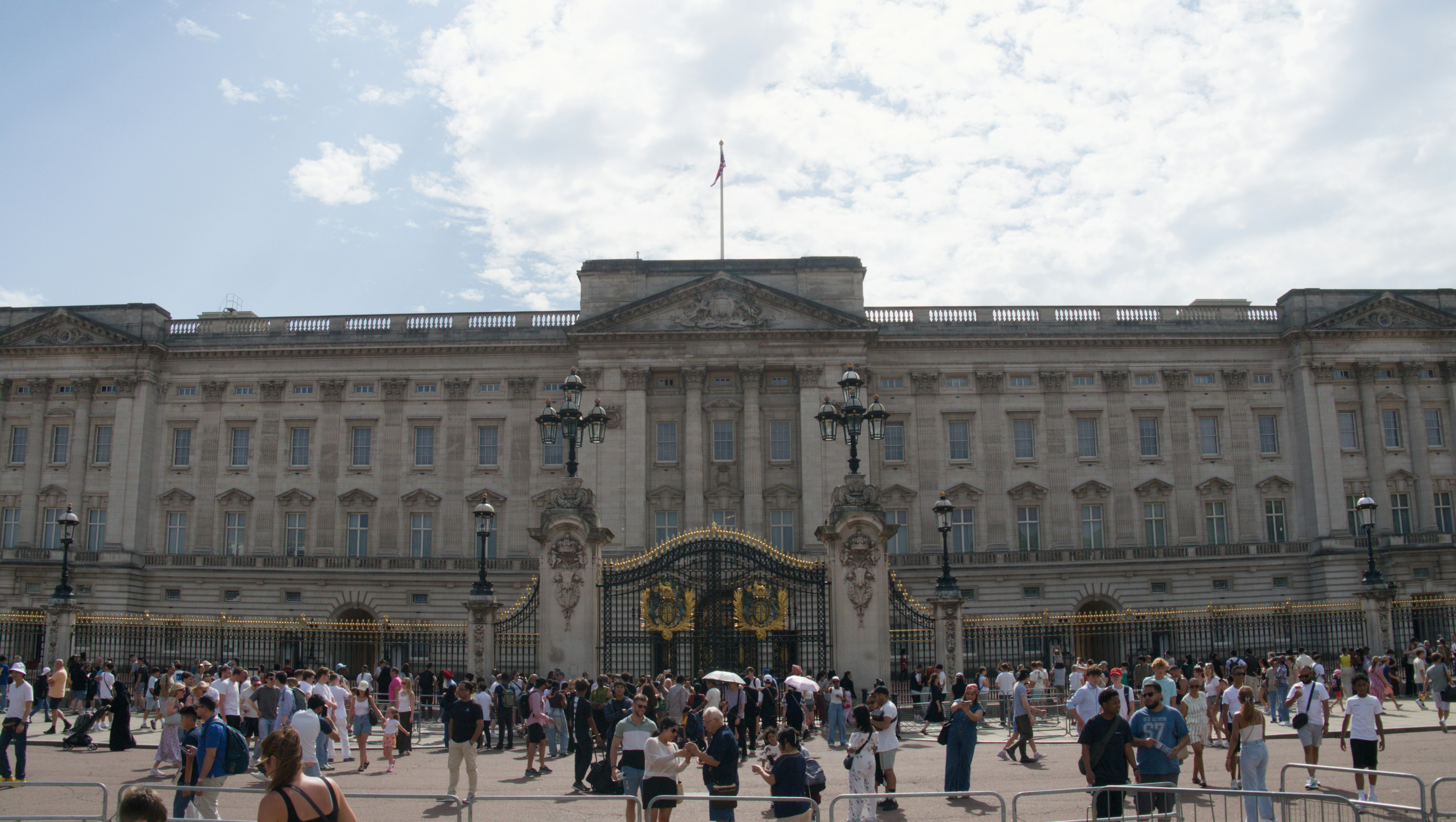 Crowd at the Grand Entrance: Pause Before the Palace Gates