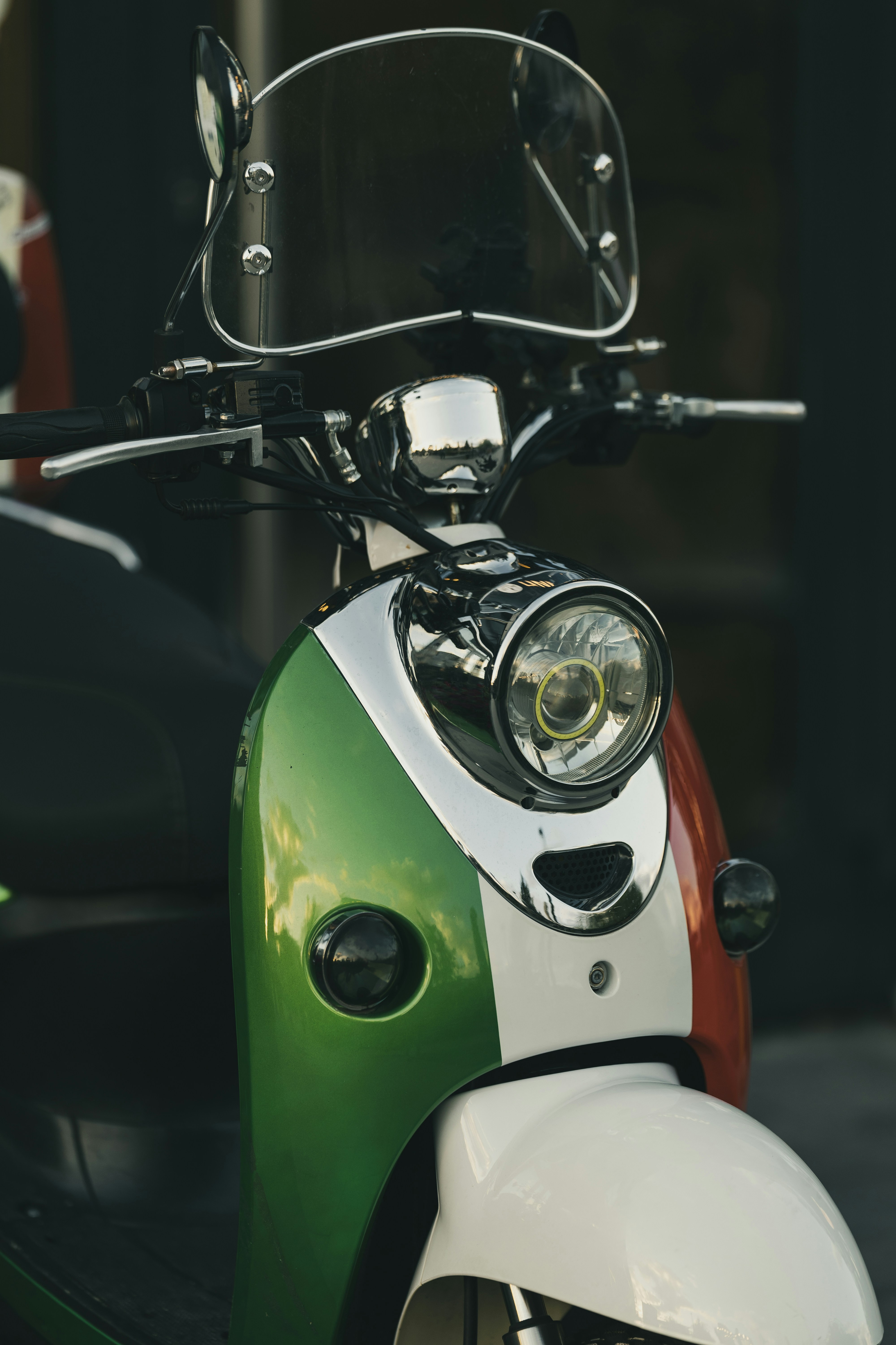 Retro Green-White-Orange Scooter Crowned by Chrome and Glass