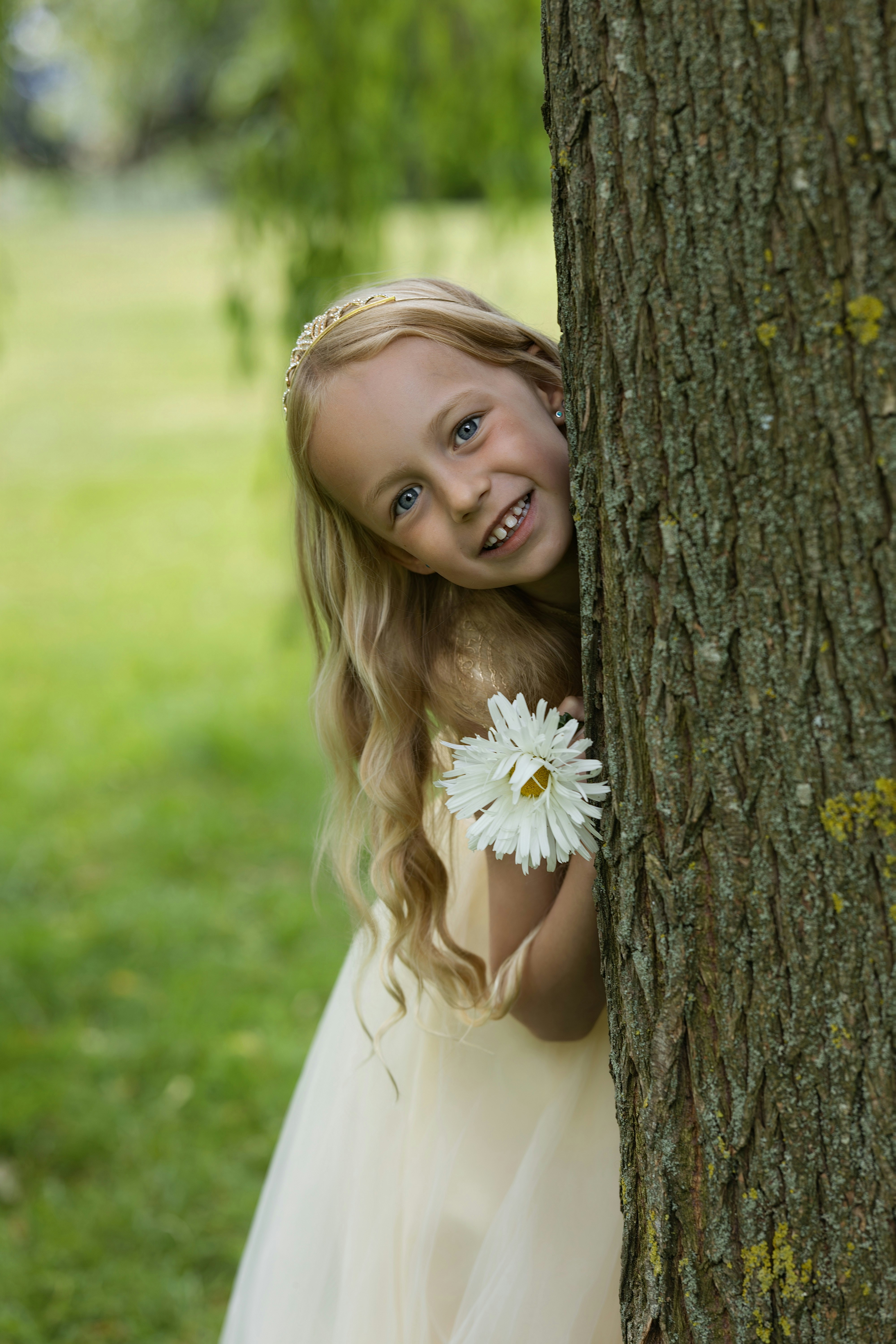 Peeking from Behind the Bark: A Sunlit Portrait of Innocence