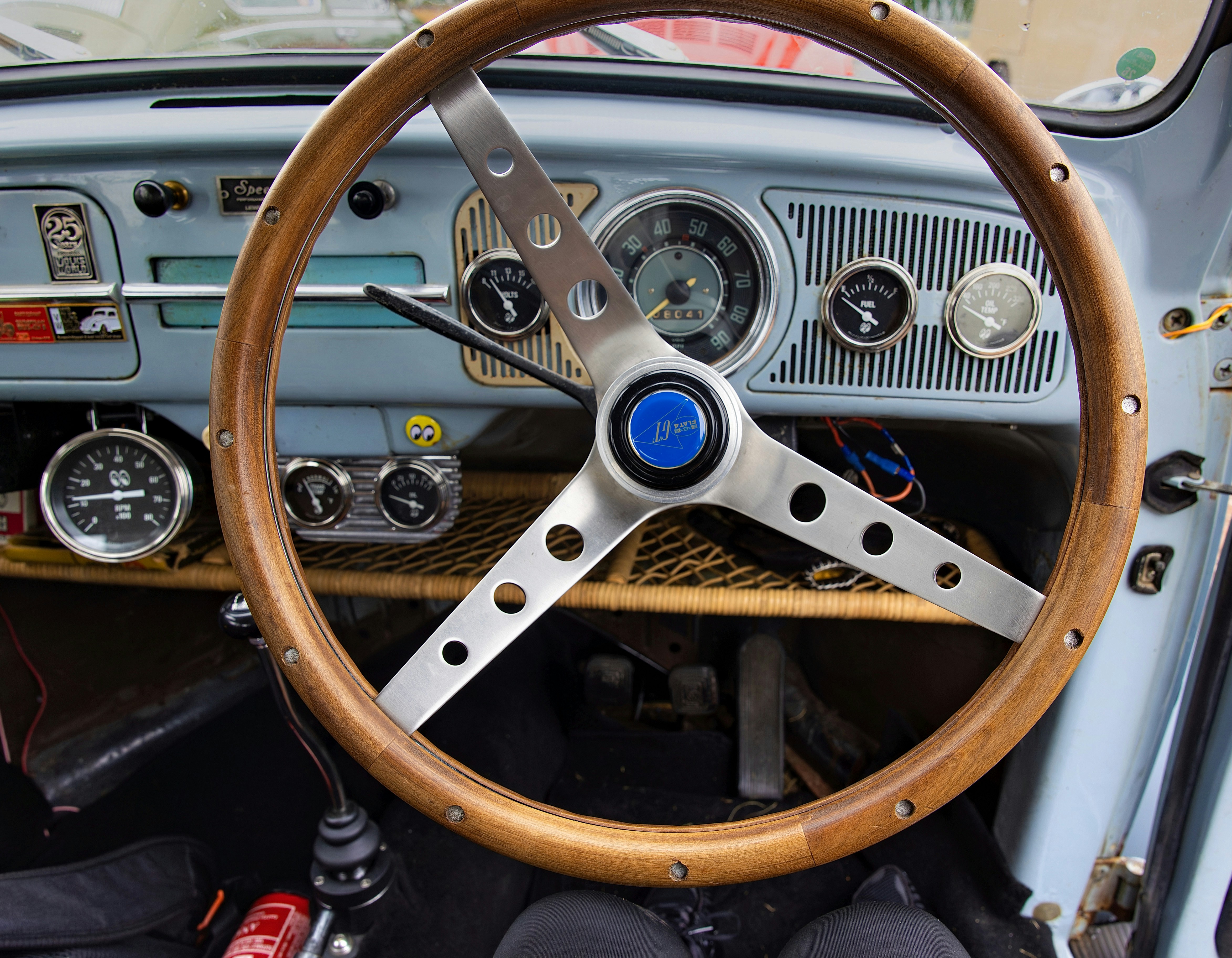 Vintage Steering Wheel, Woven Dash, and Gauges: a Classic Car Cockpit