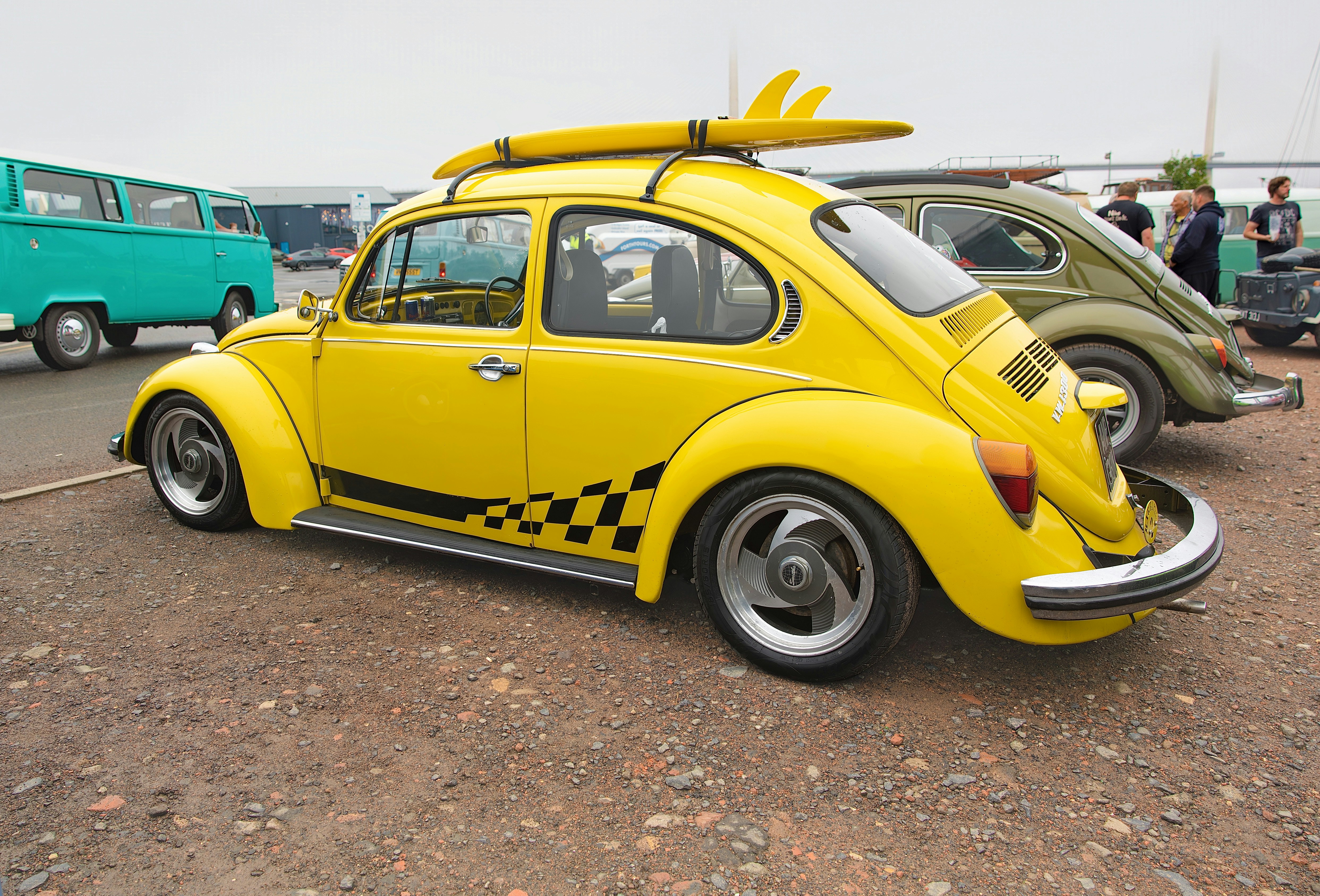Sunlit Yellow Beetle: Surfboard Rendezvous in the Parking Lot