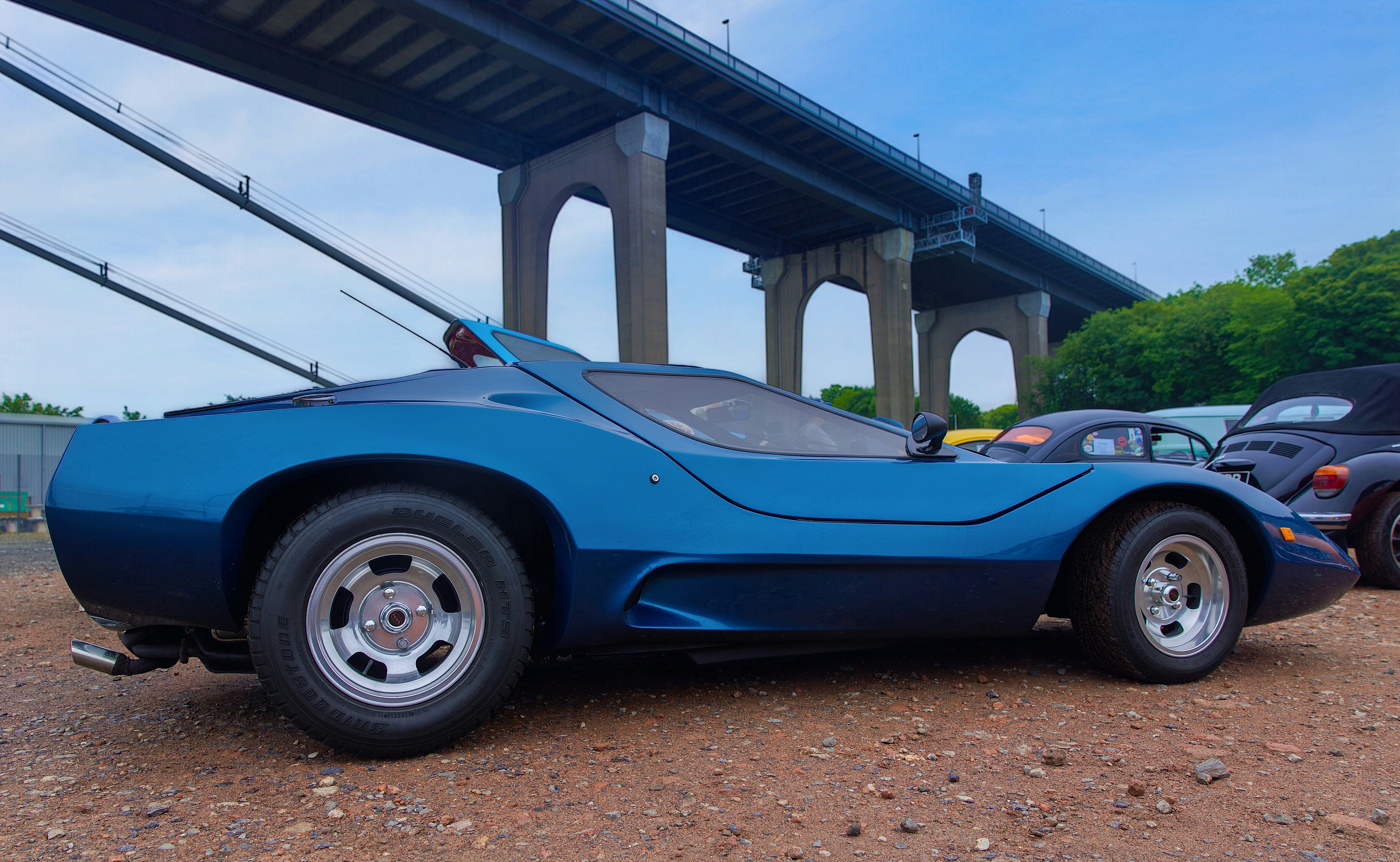 Blue Retro Racer Resting Under a Bridge