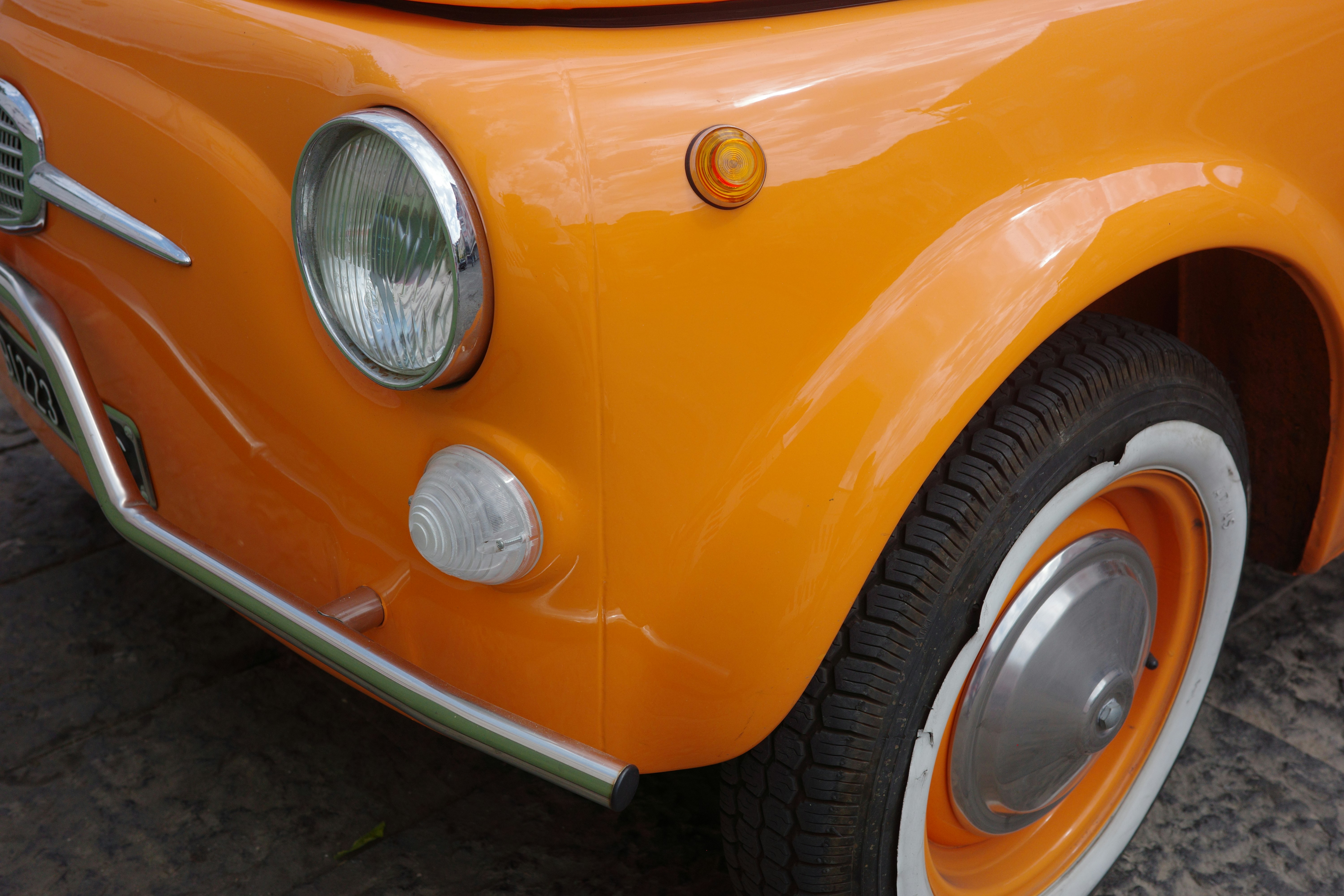 Sunlit Orange Vintage: The Front Quarter of a Classic Car