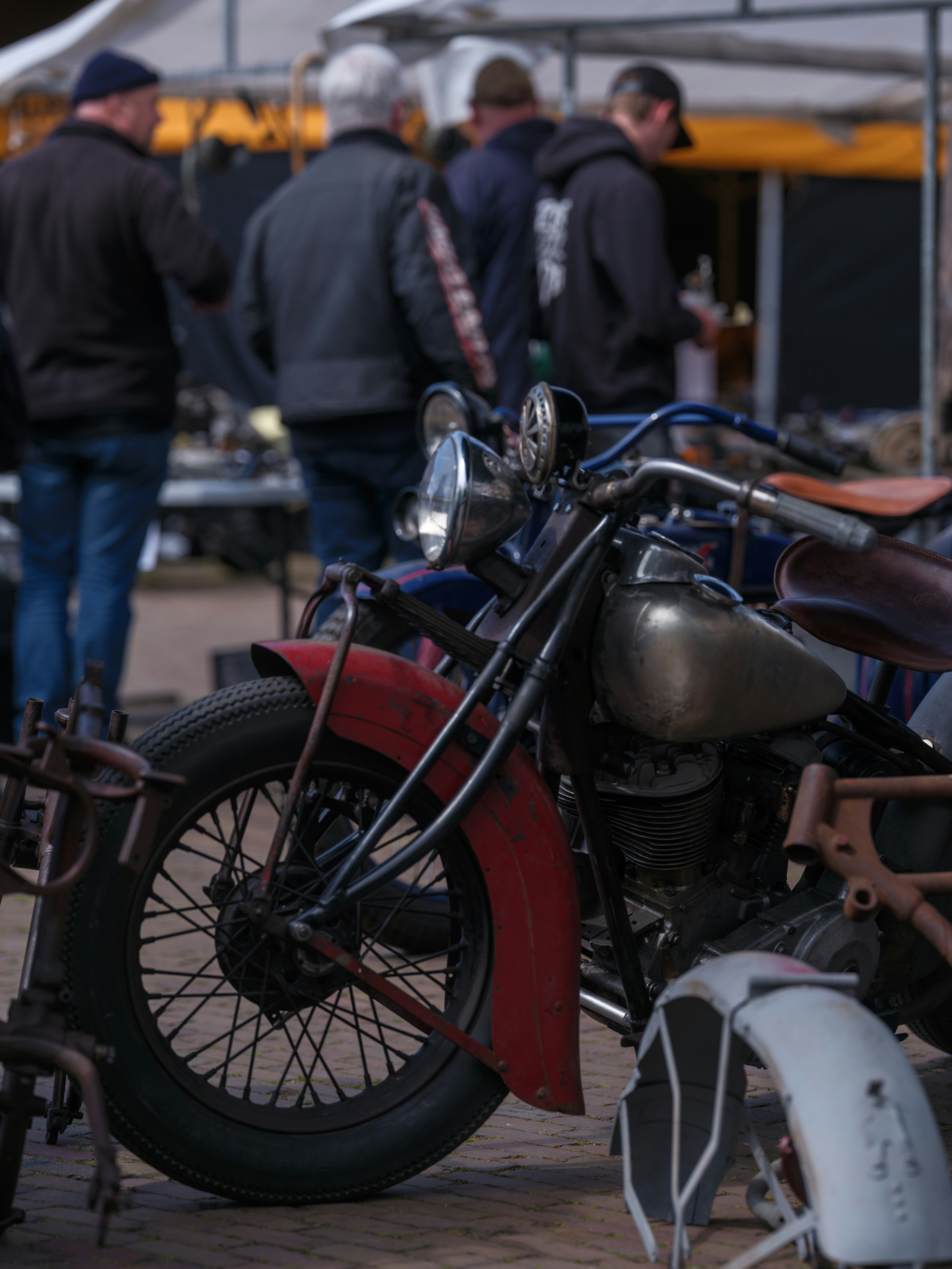 Vintage Motorcycle at a Market Show: Steel, Leather and People